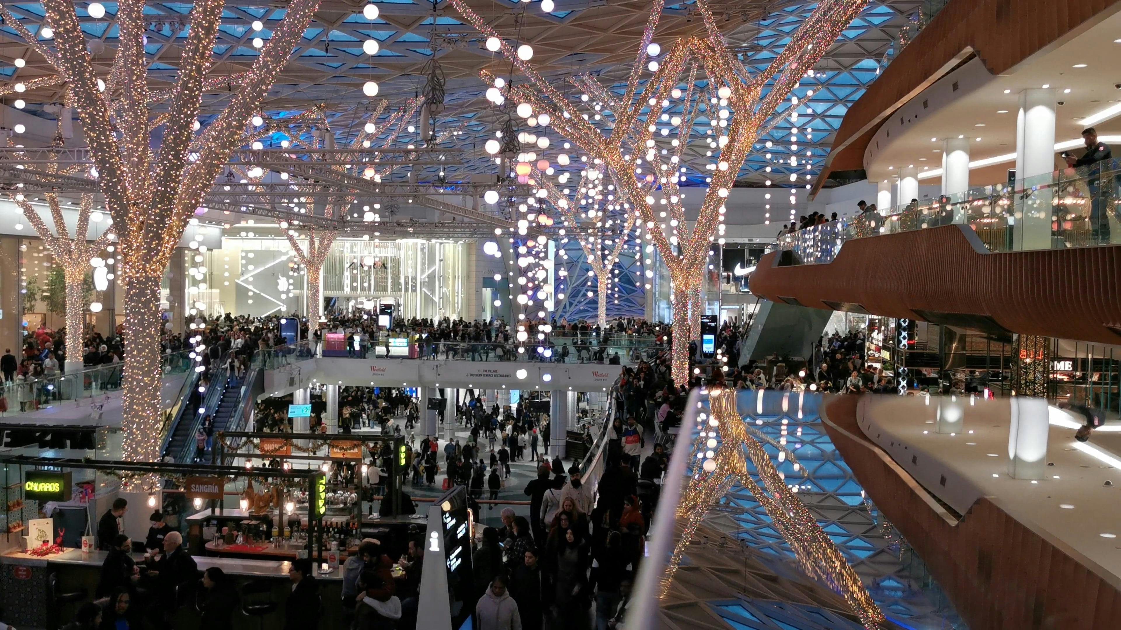 A Crowded Shopping Mall Decorated with Christmas Lights Free Stock ...