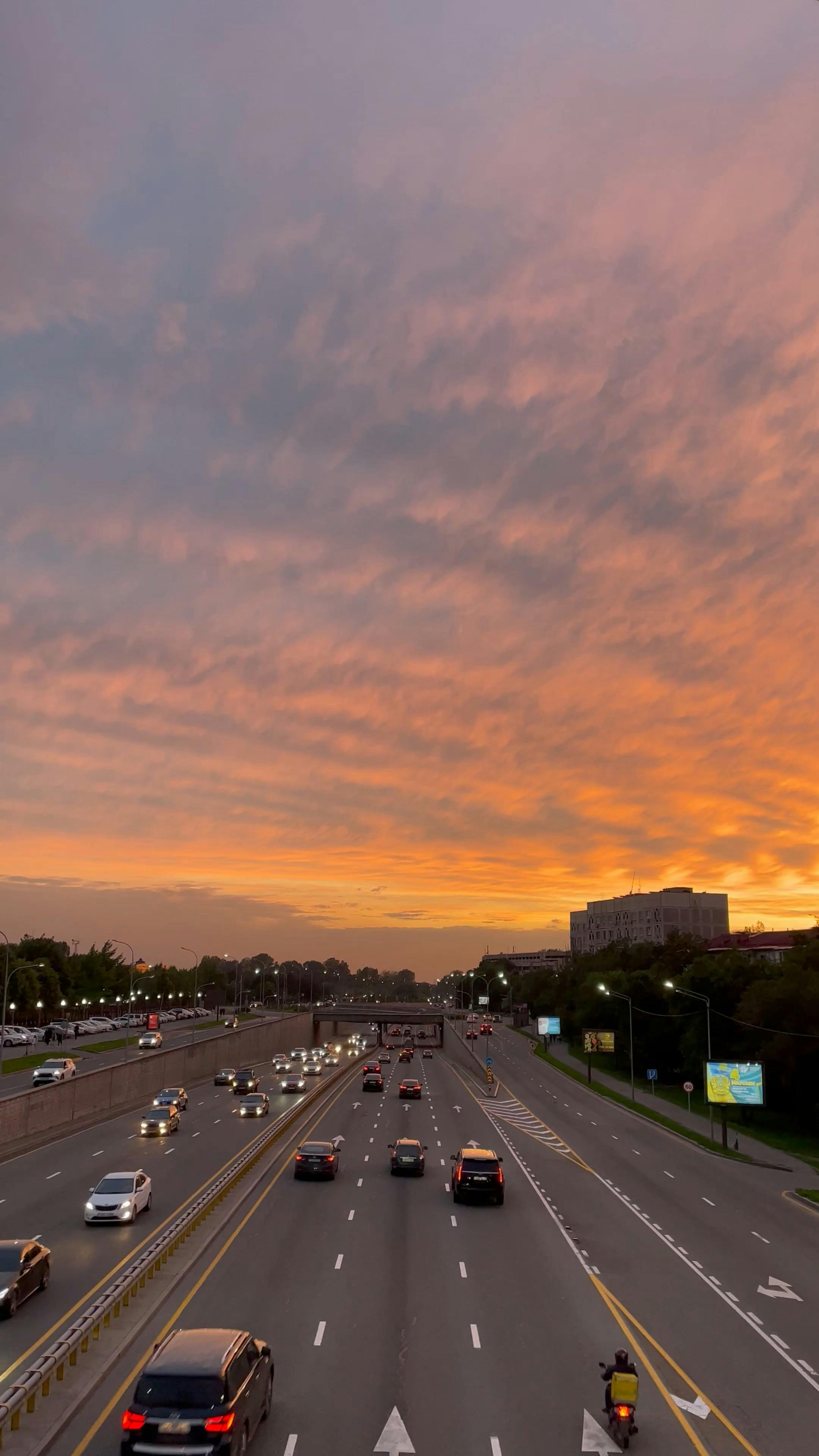 A sunset over a highway with cars driving on it Free Stock Video ...