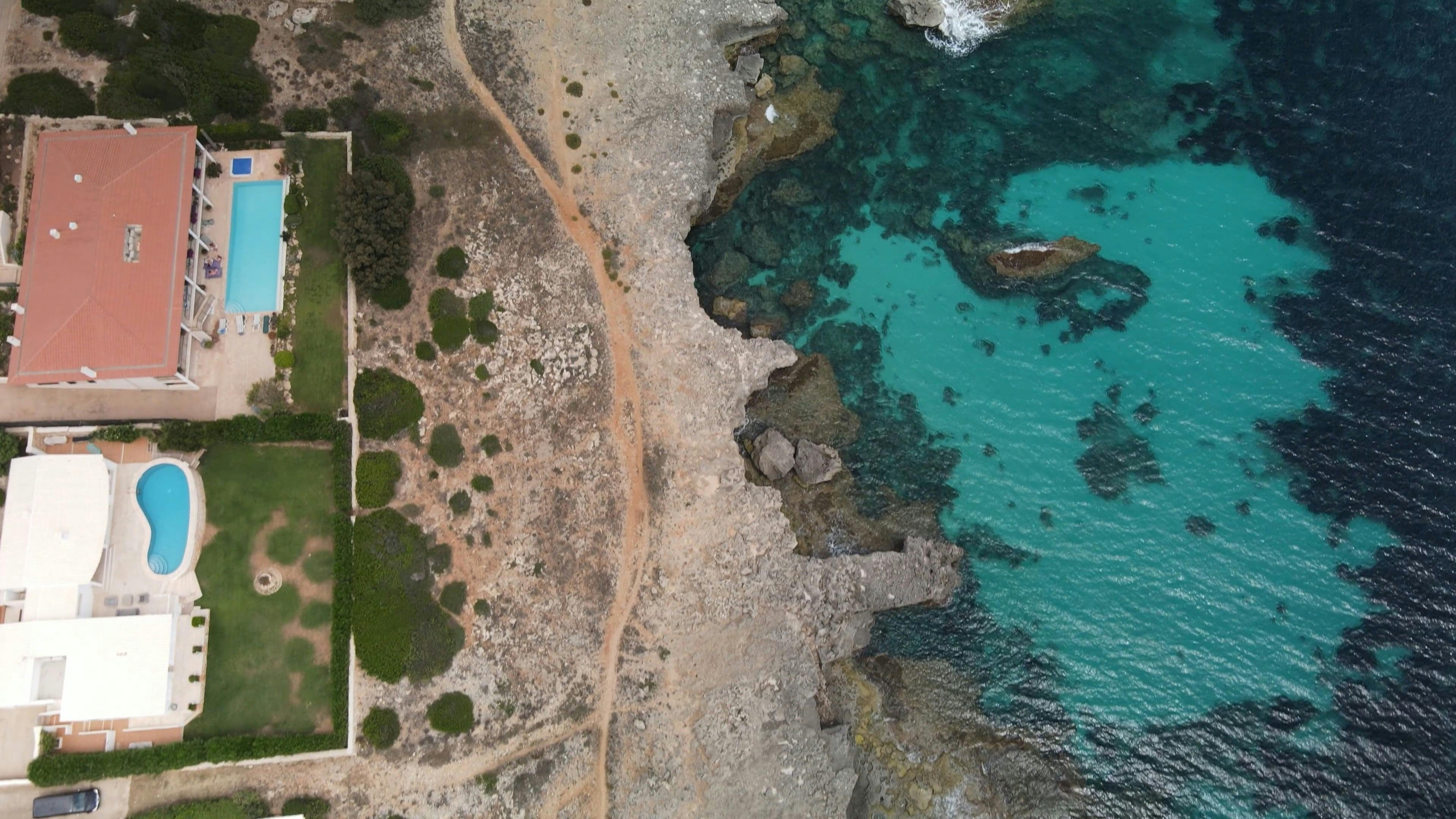 A Drone Footage of a Beach Near the Resorts with Swimming Pools Free ...
