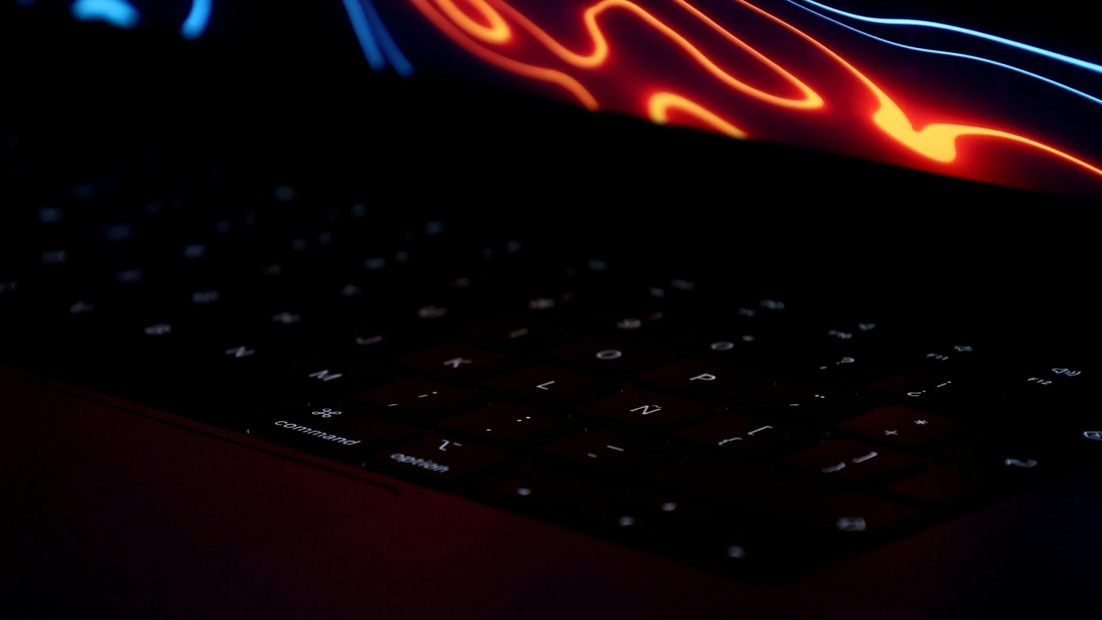 Close up of a Laptop Keyboard and a Colorful Screensaver Free Stock ...