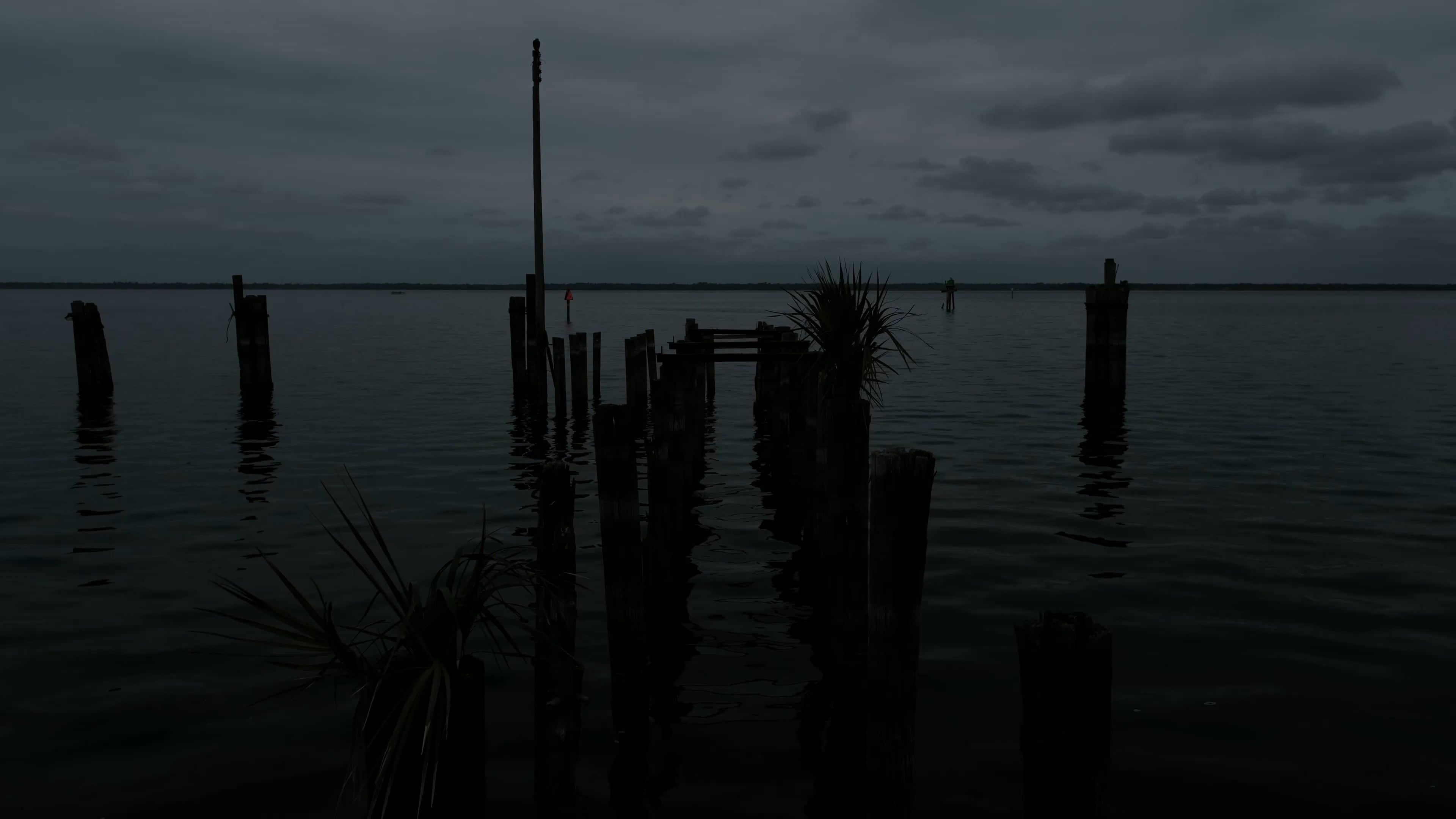 A dark sky with a pier in the water Free Stock Video Footage, Royalty ...