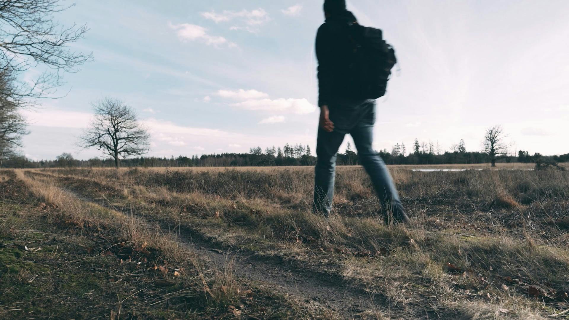 A Man Walking along an Off Road Trail in the Countryside Free Stock ...