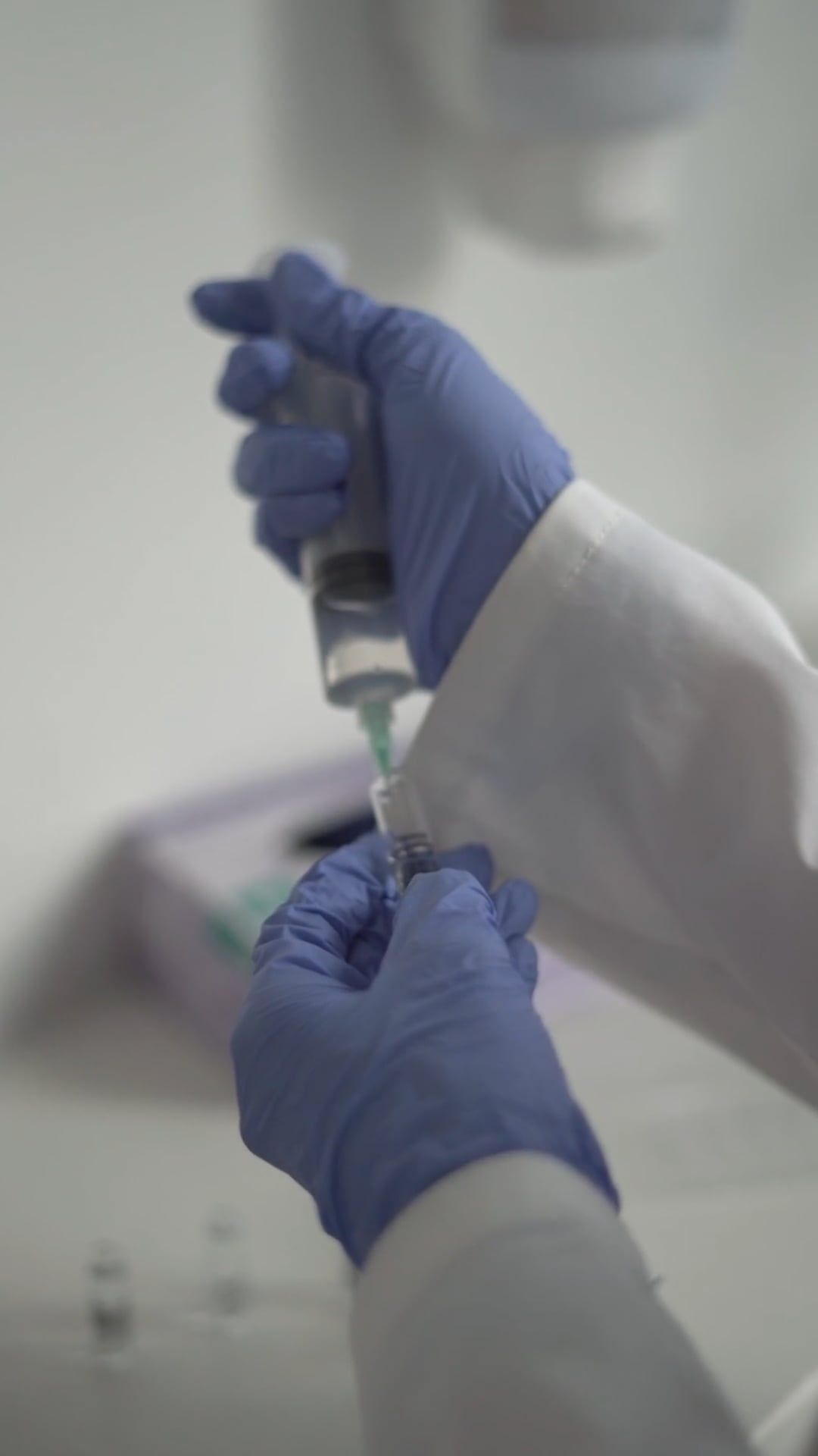 Close up of a Person Using a Syringe to Withdraw Medication from an ...