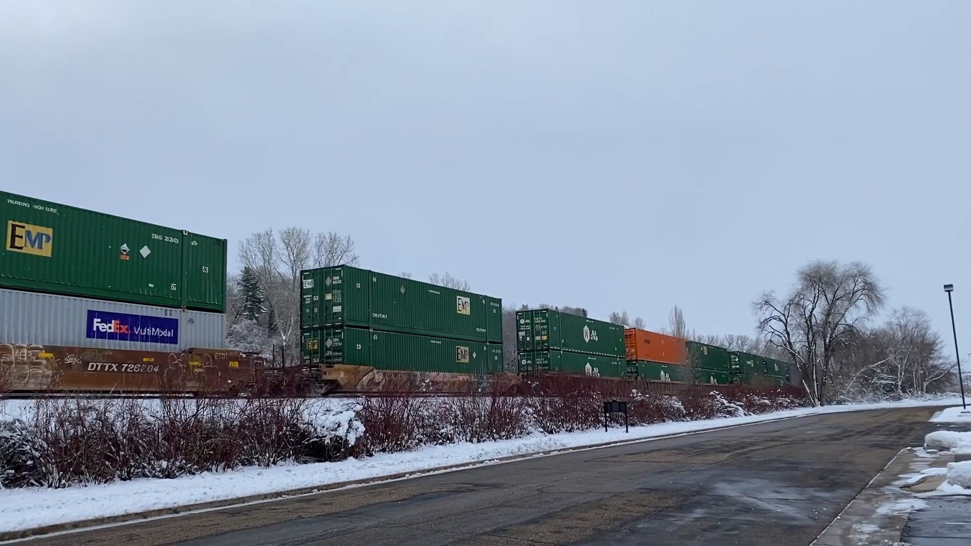 A Freight Train Transporting Cargo Containers on a Snowy Winter Day ...