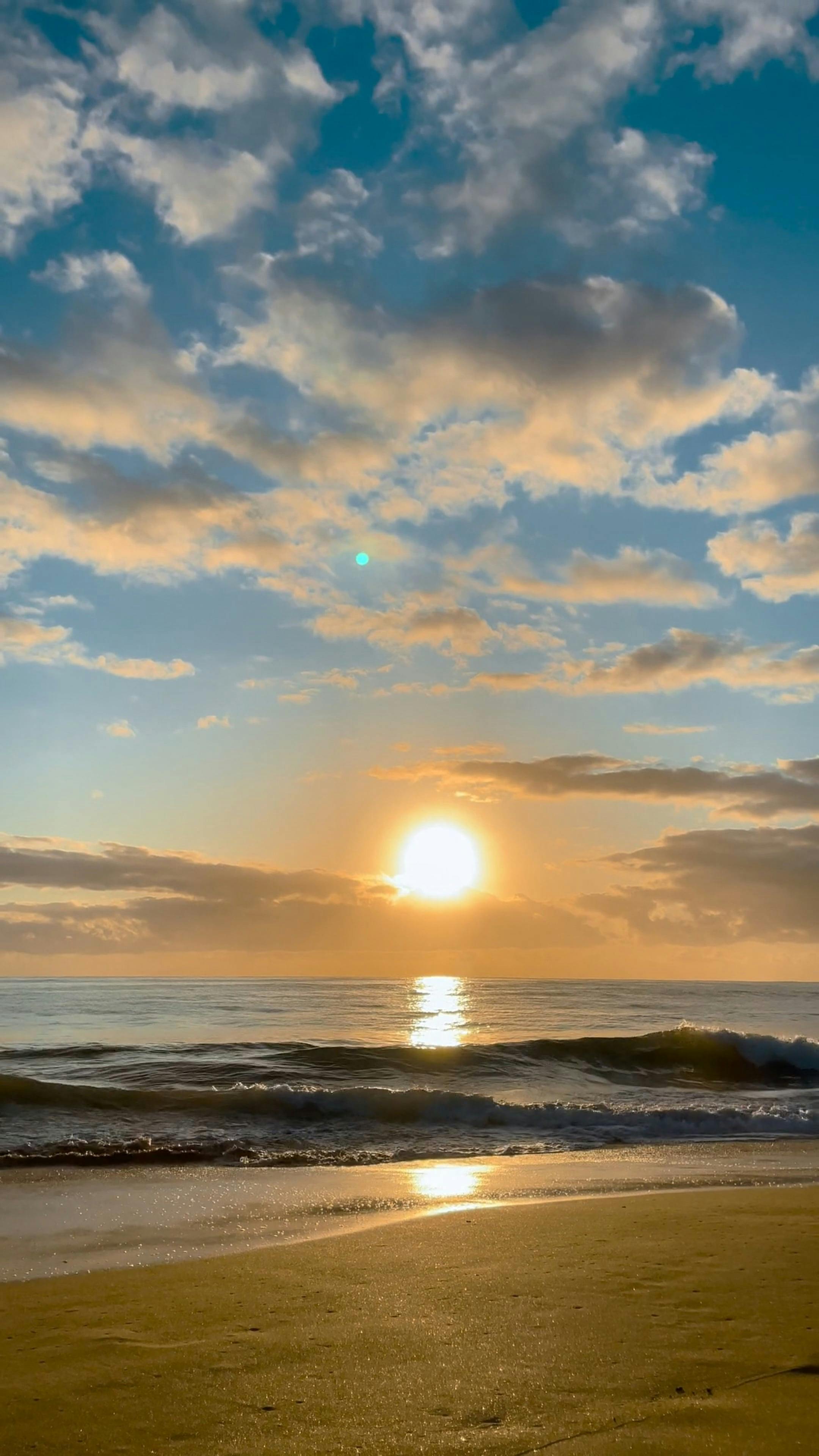 Ground Level Footage Of Waves Breaking On The Shore With The Sun ...