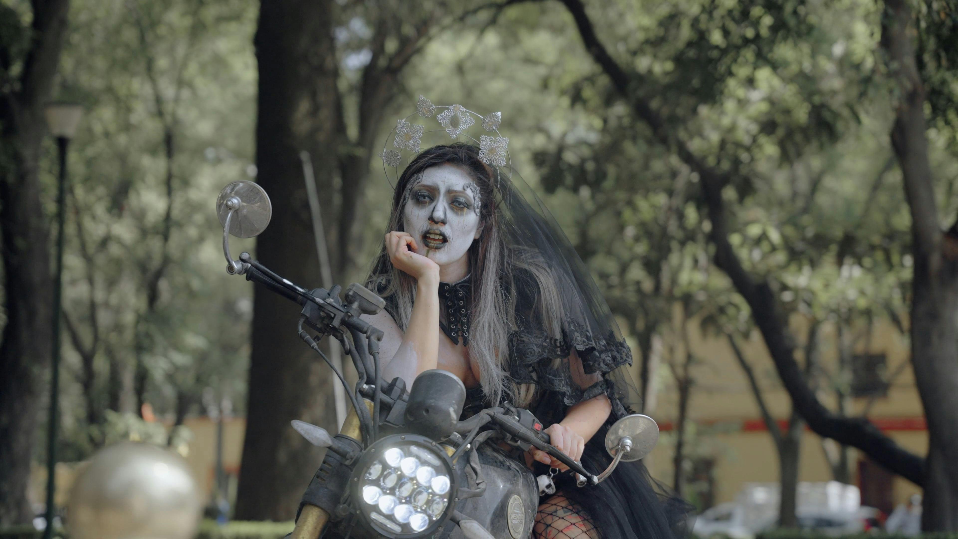 A woman dressed in black and white makeup riding a motorcycle Free ...