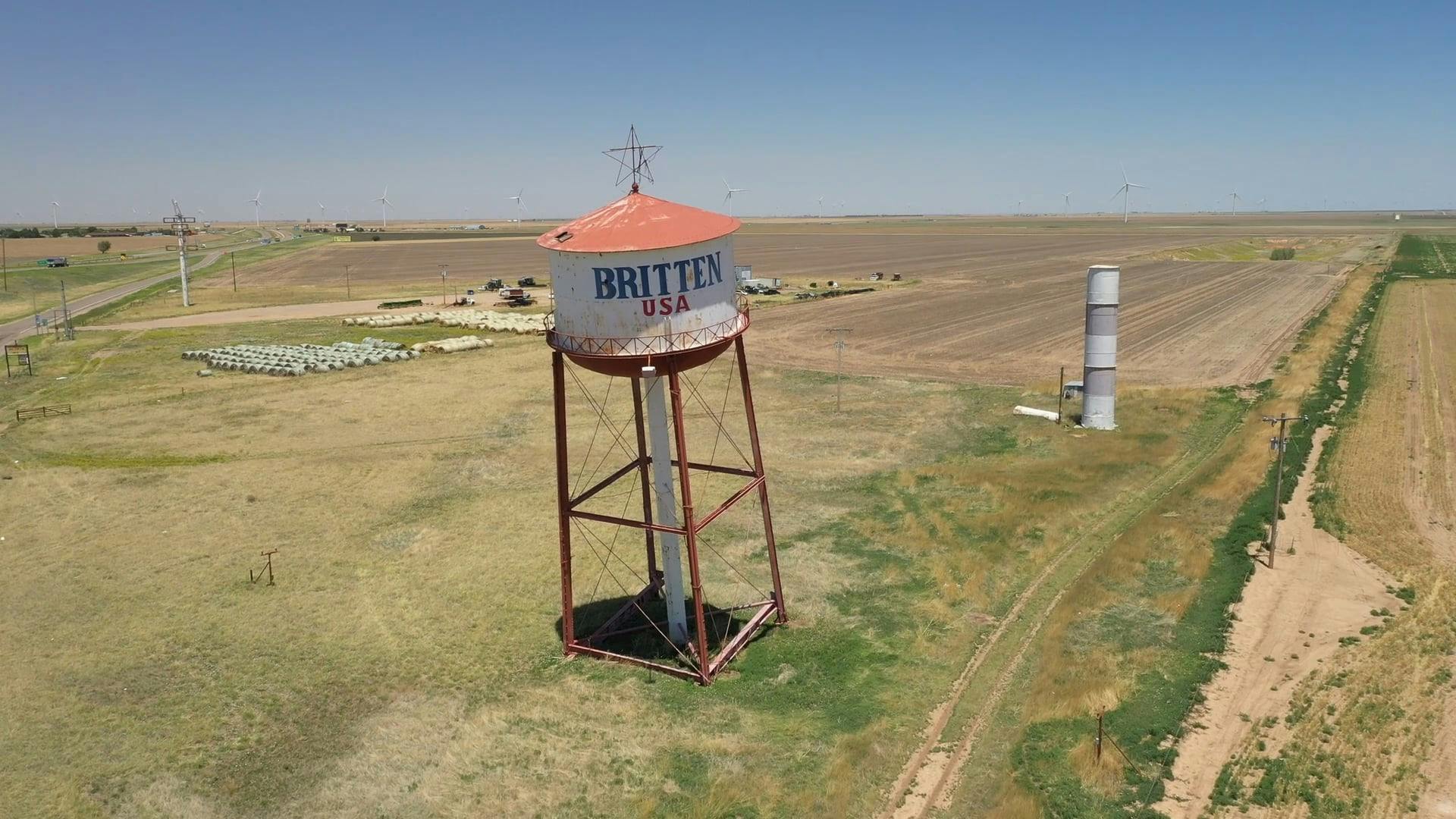 An aerial view of a water tower in a field Free Stock Video Footage ...