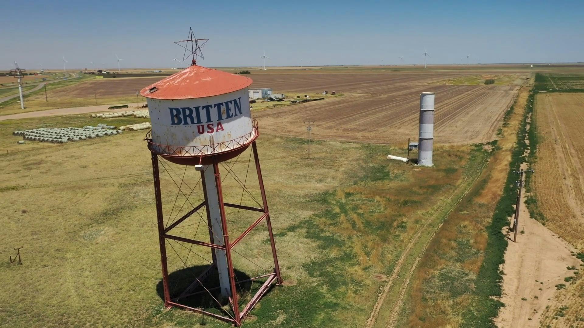 An aerial view of a water tower in the middle of a field Free Stock ...