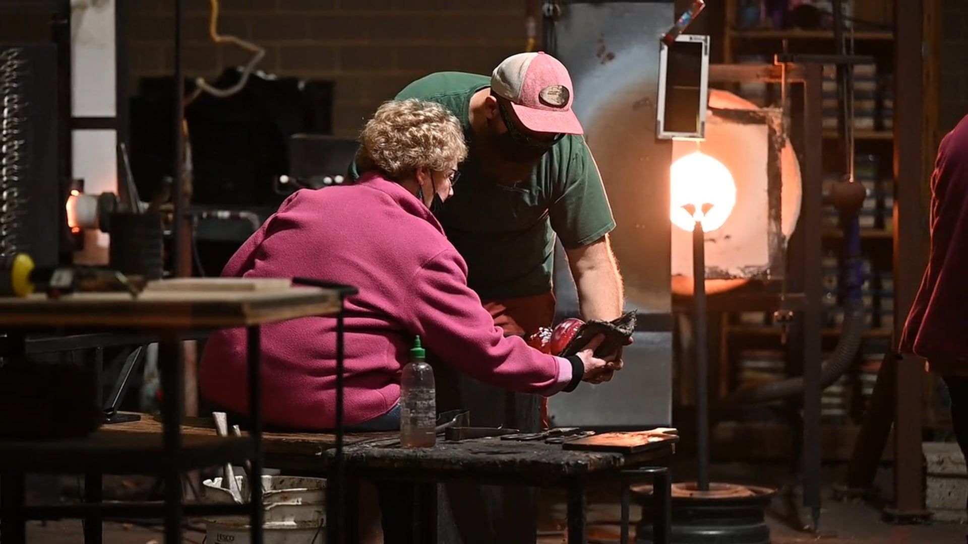 A Glassblower and an Elderly Woman Shaping Glass Together Free Stock ...