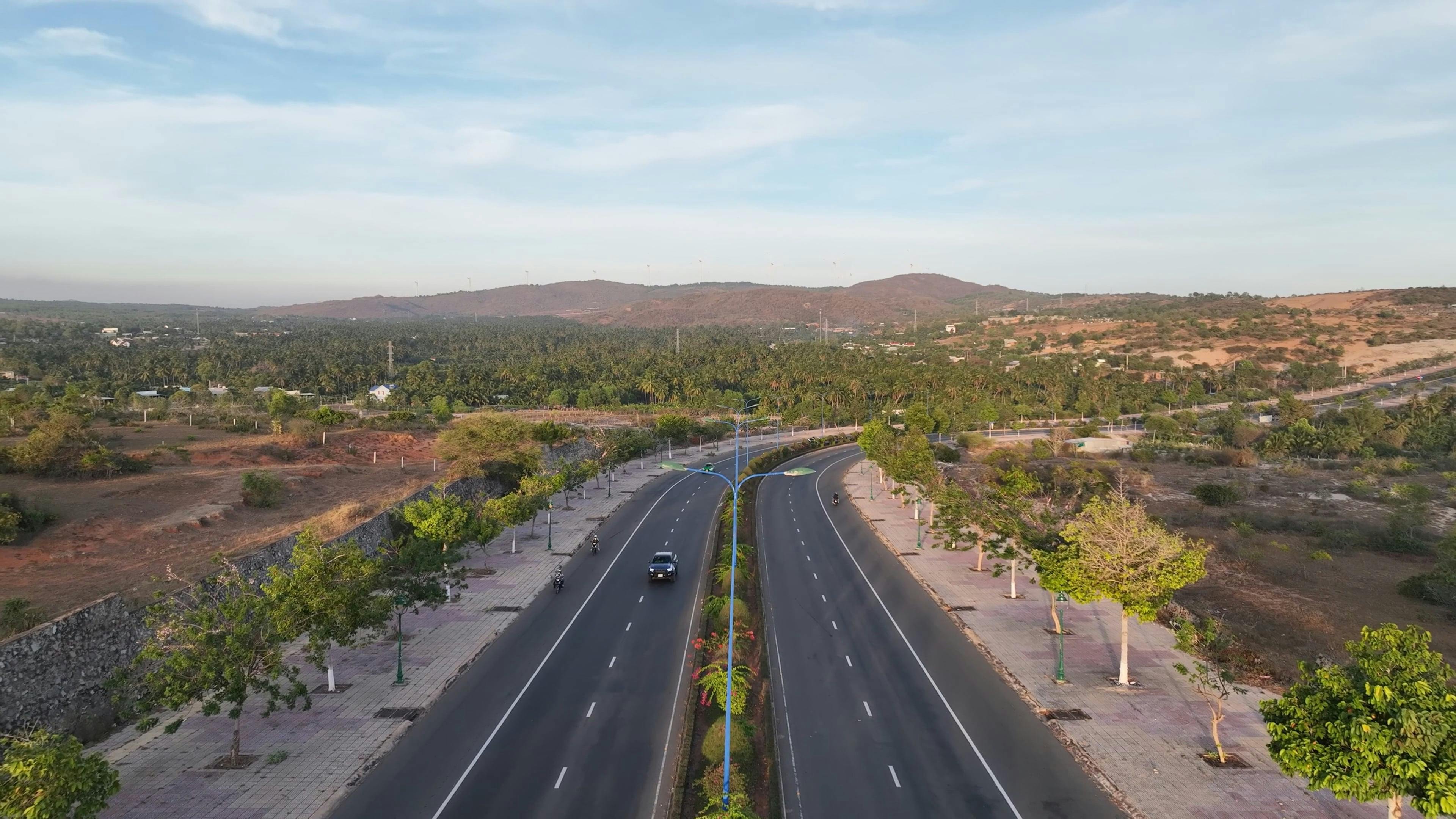 An aerial view of a highway with trees and a road Free Stock Video ...