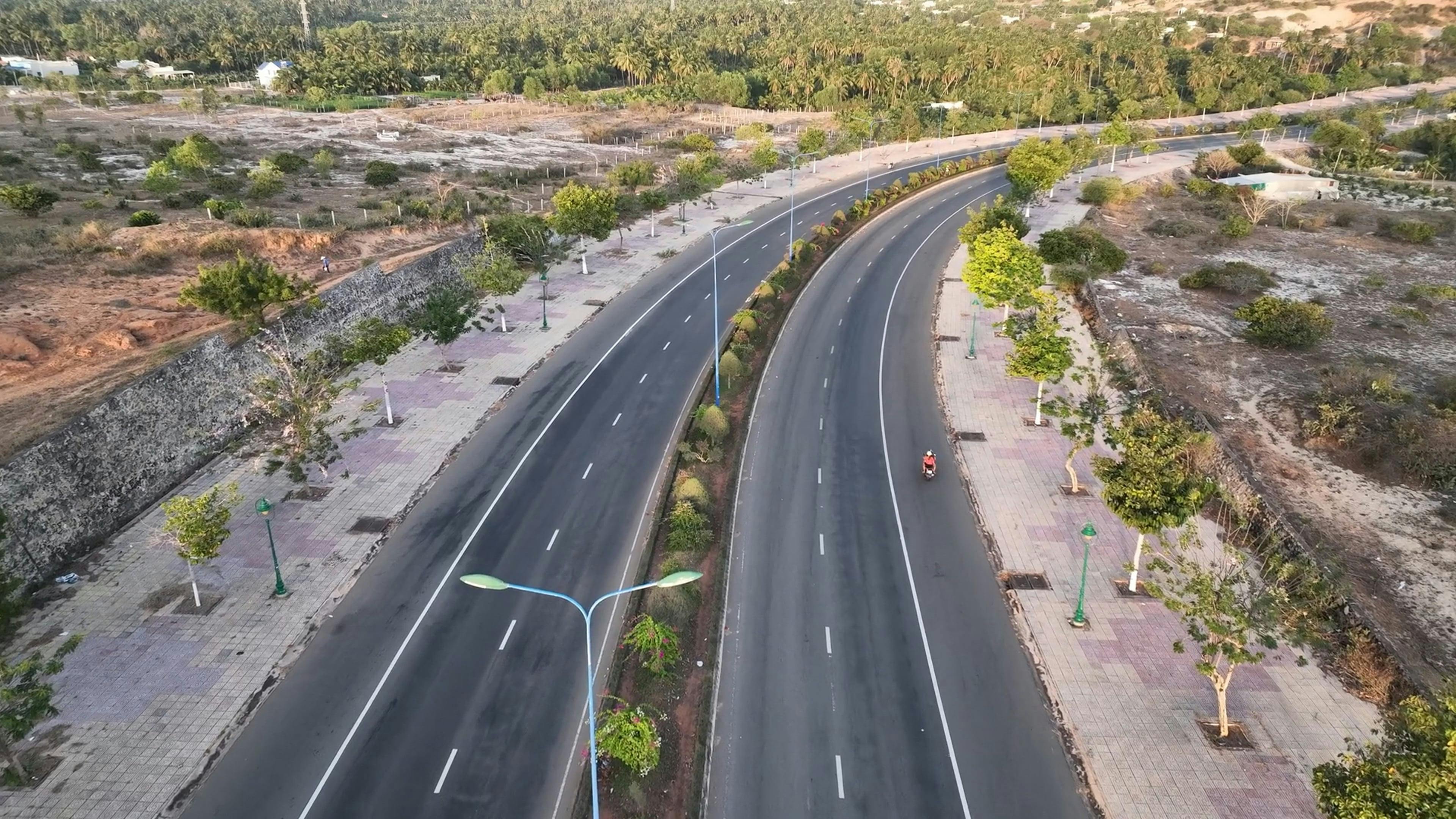 An aerial view of a highway with trees and buildings Free Stock Video ...