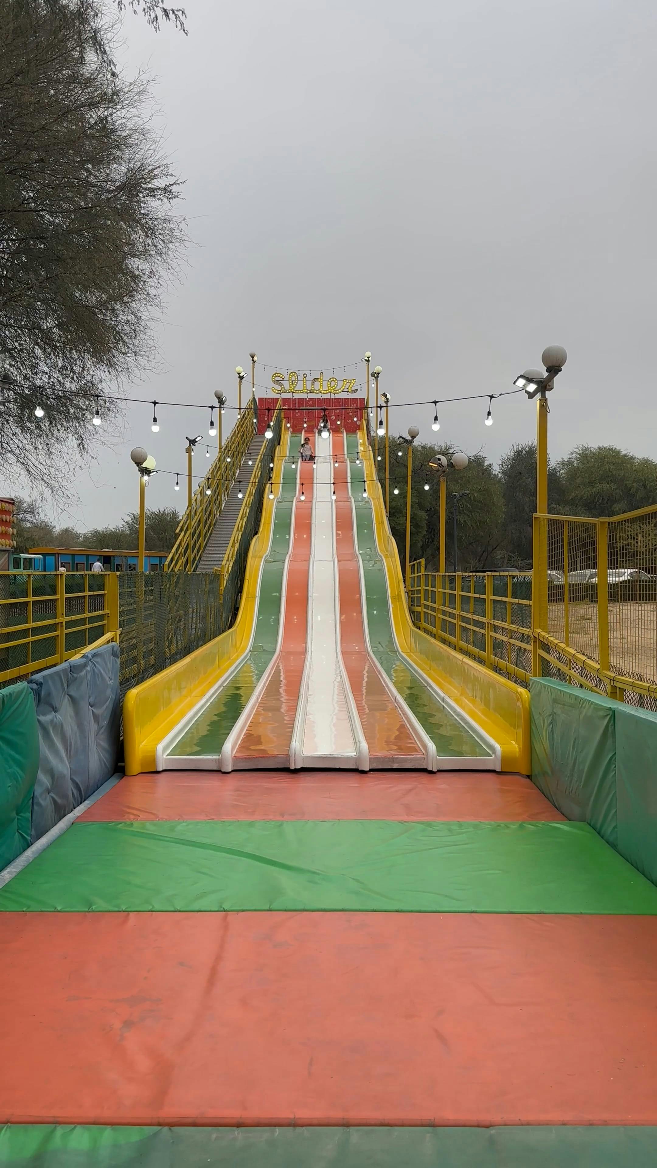 Two Girls Having Fun at a Cascade Slide in an Amusement Park Free Stock ...