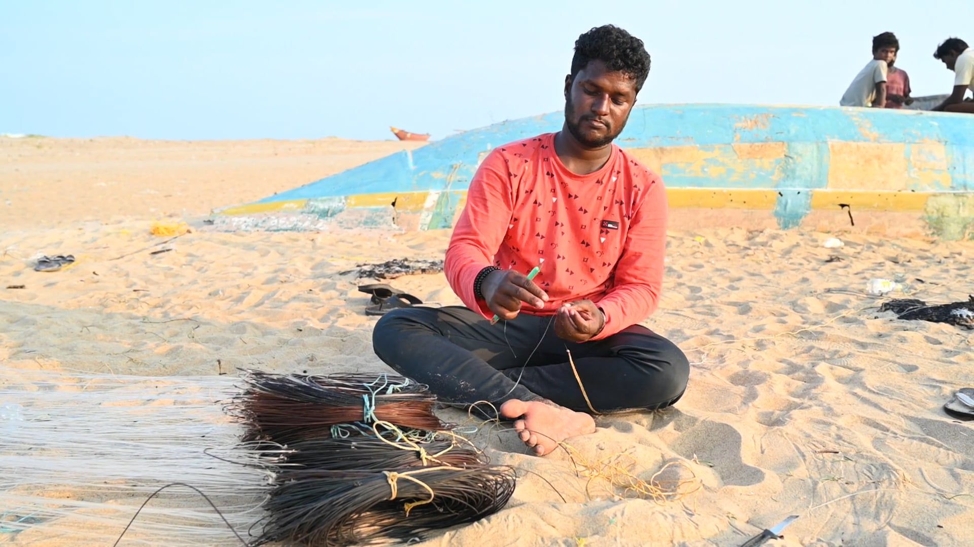 A man sitting on the sand with a bunch of hair Free Stock Video Footage ...