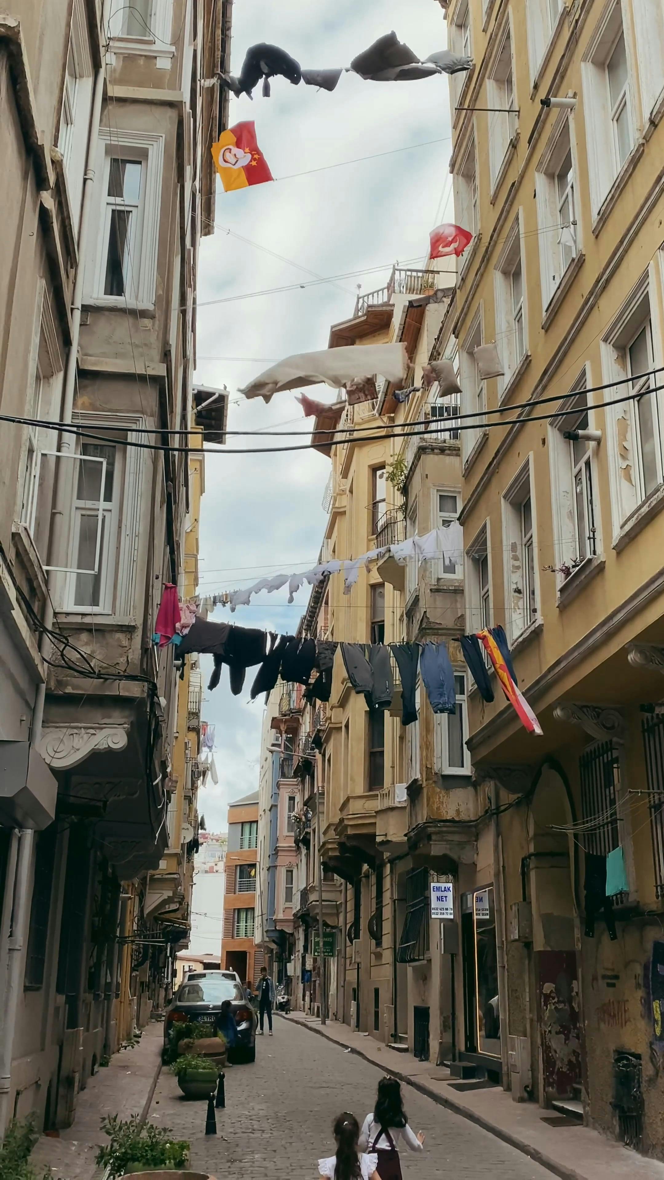A narrow street with clothes hanging from the clothes line Free Stock ...