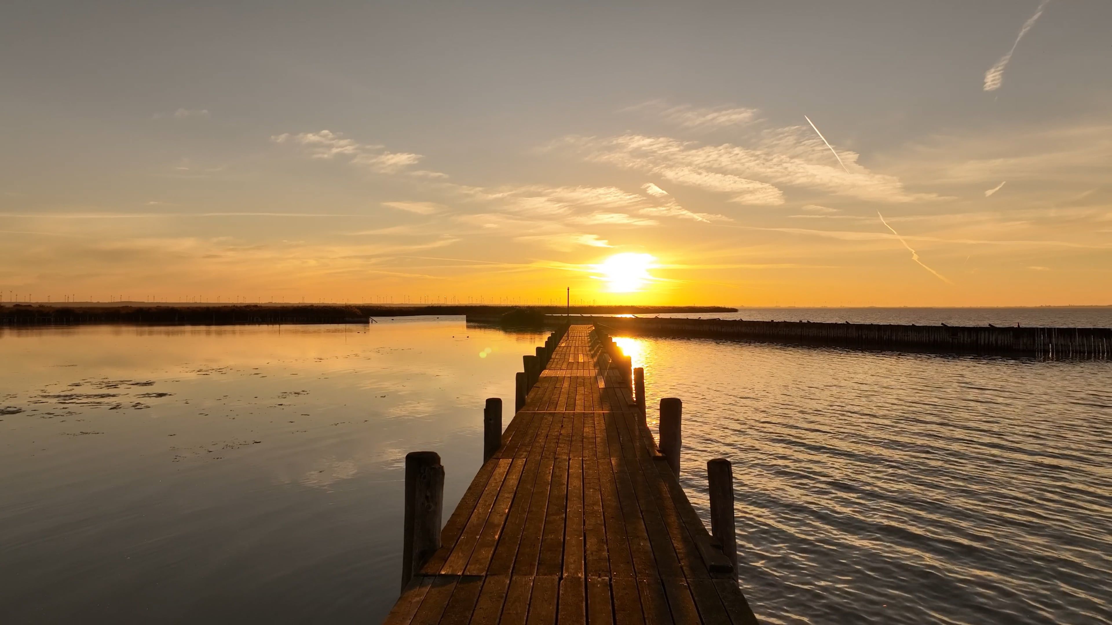 The sun sets over the water at a pier Free Stock Video Footage, Royalty ...