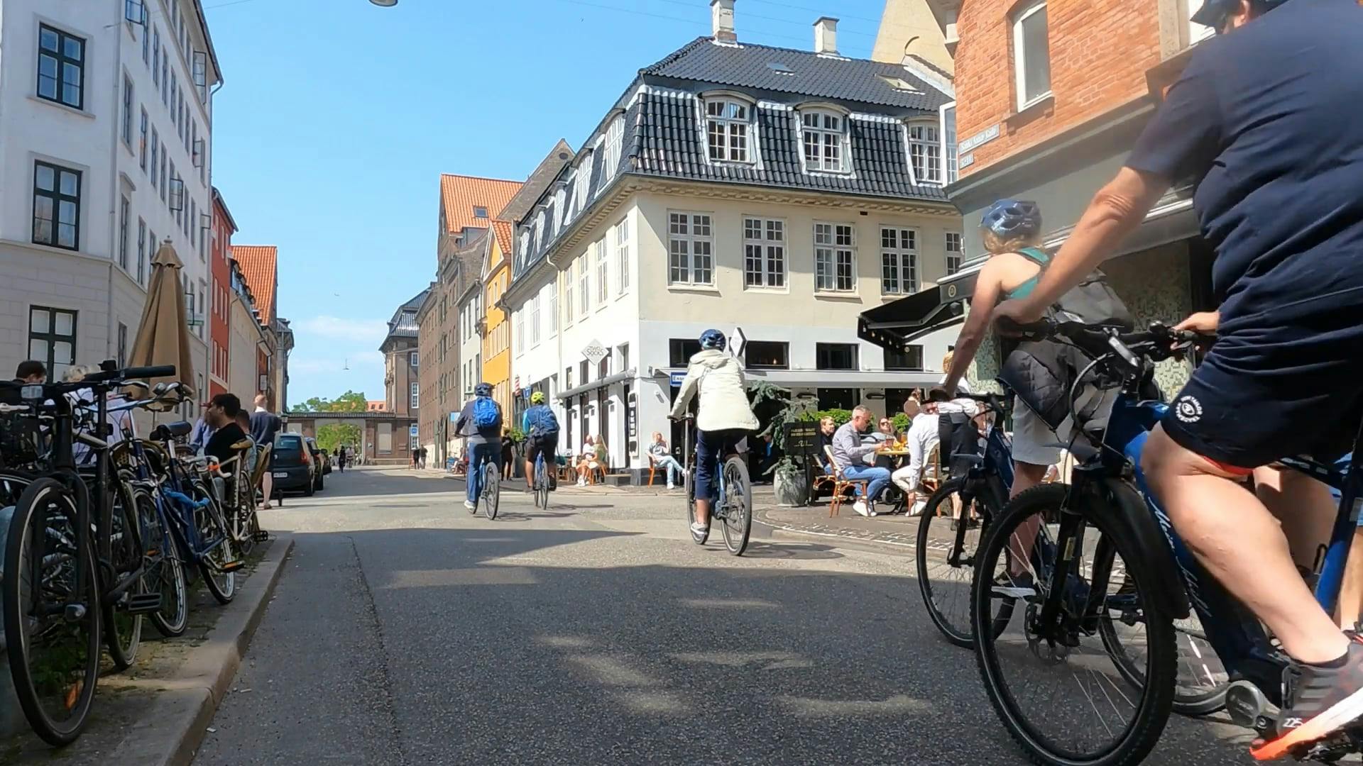 A group of people riding bikes down a city street Free Stock Video ...