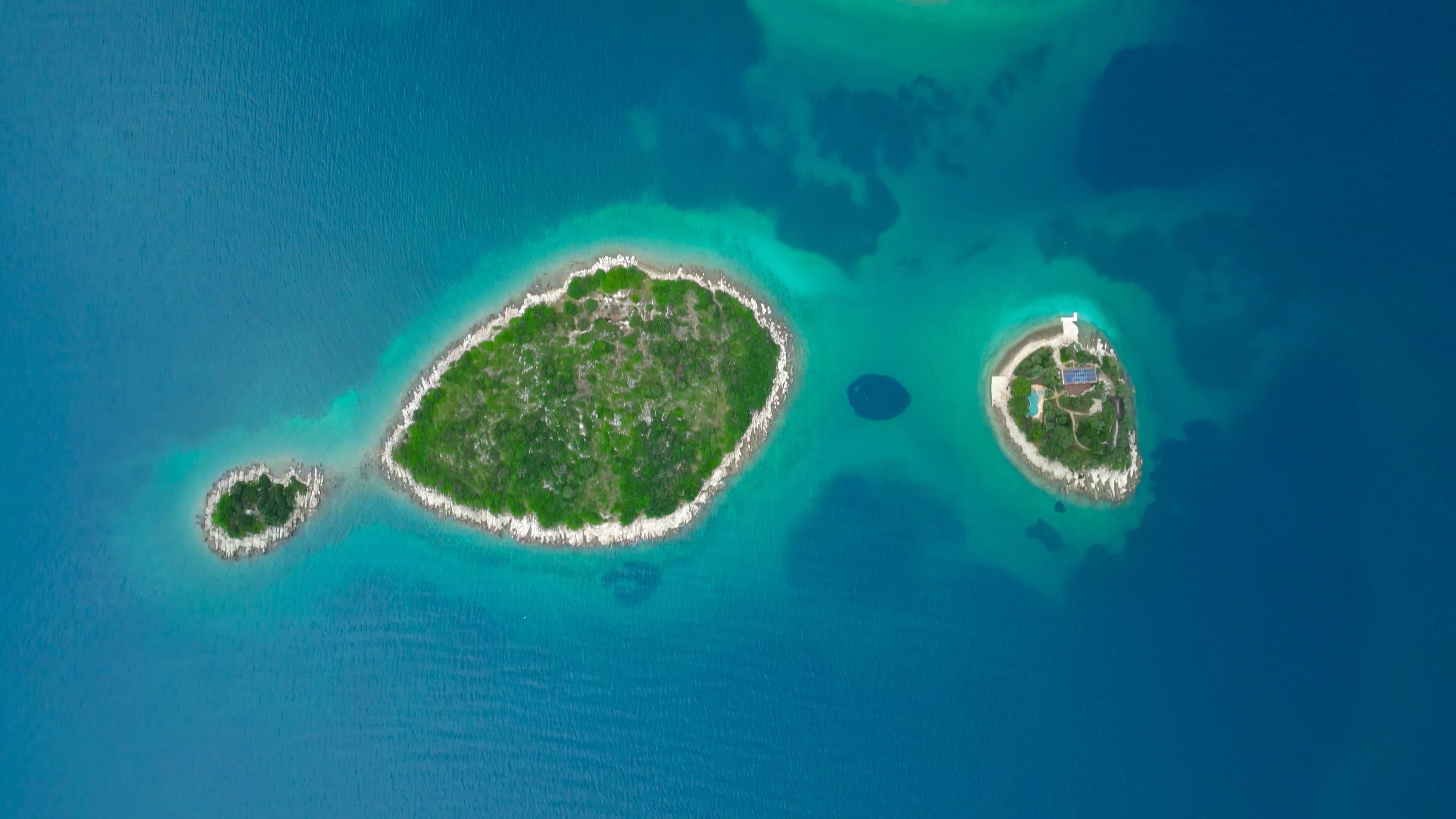 An aerial view of two islands with green water Free Stock Video Footage ...