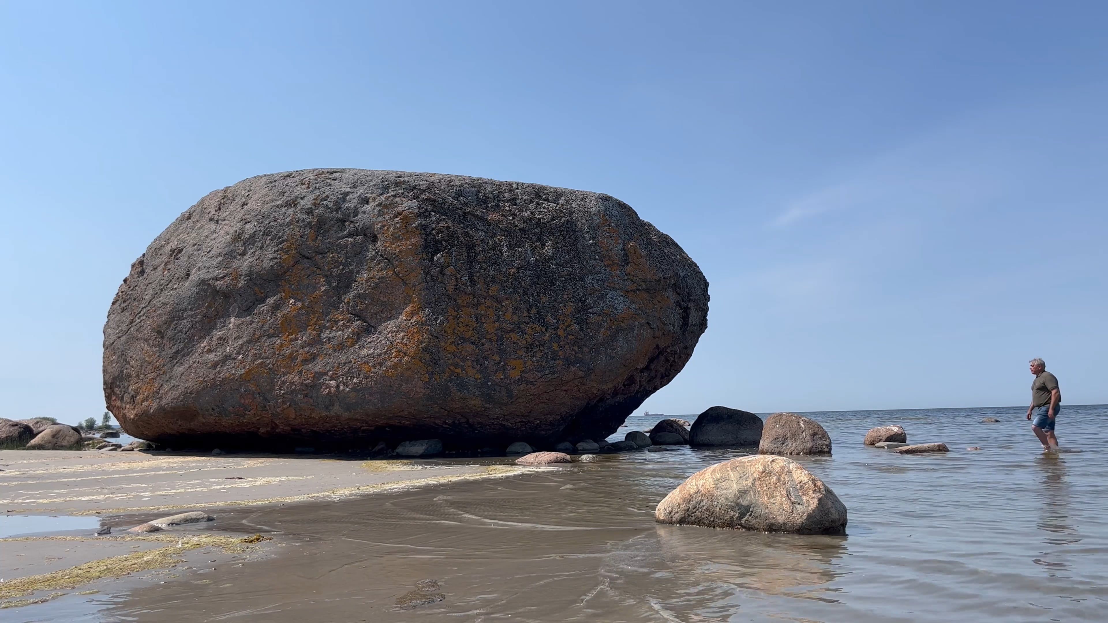 A Man Walking near a Large Rock on the Beach Free Stock Video Footage ...