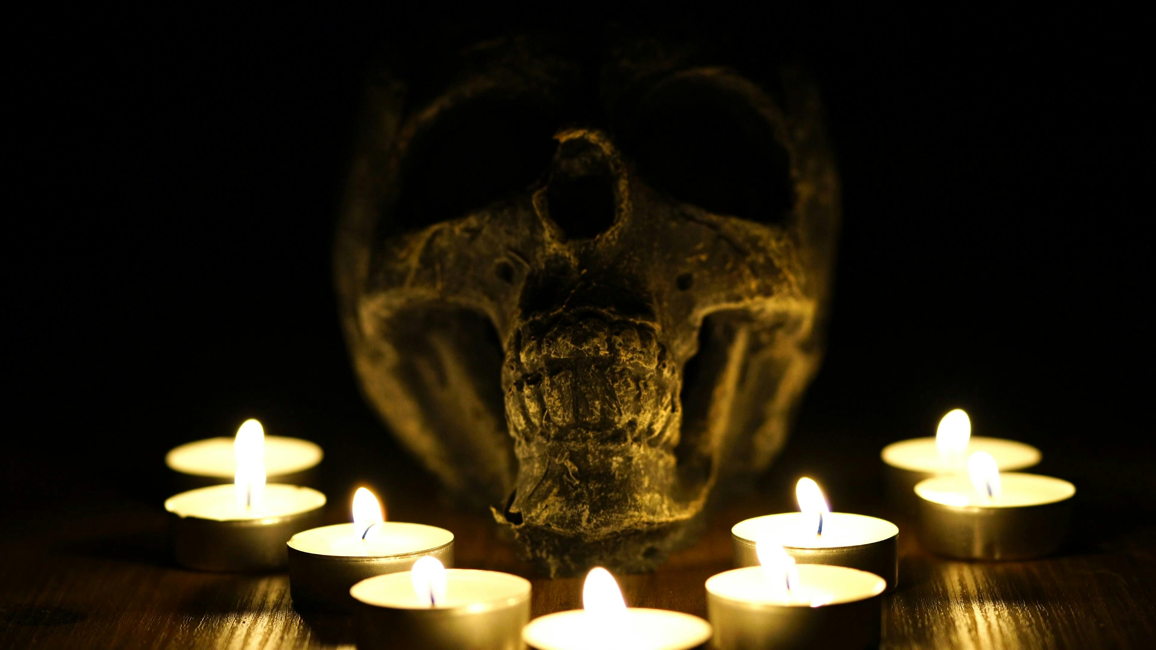 A Skull With Lighted Tea Candles · Free Stock Video