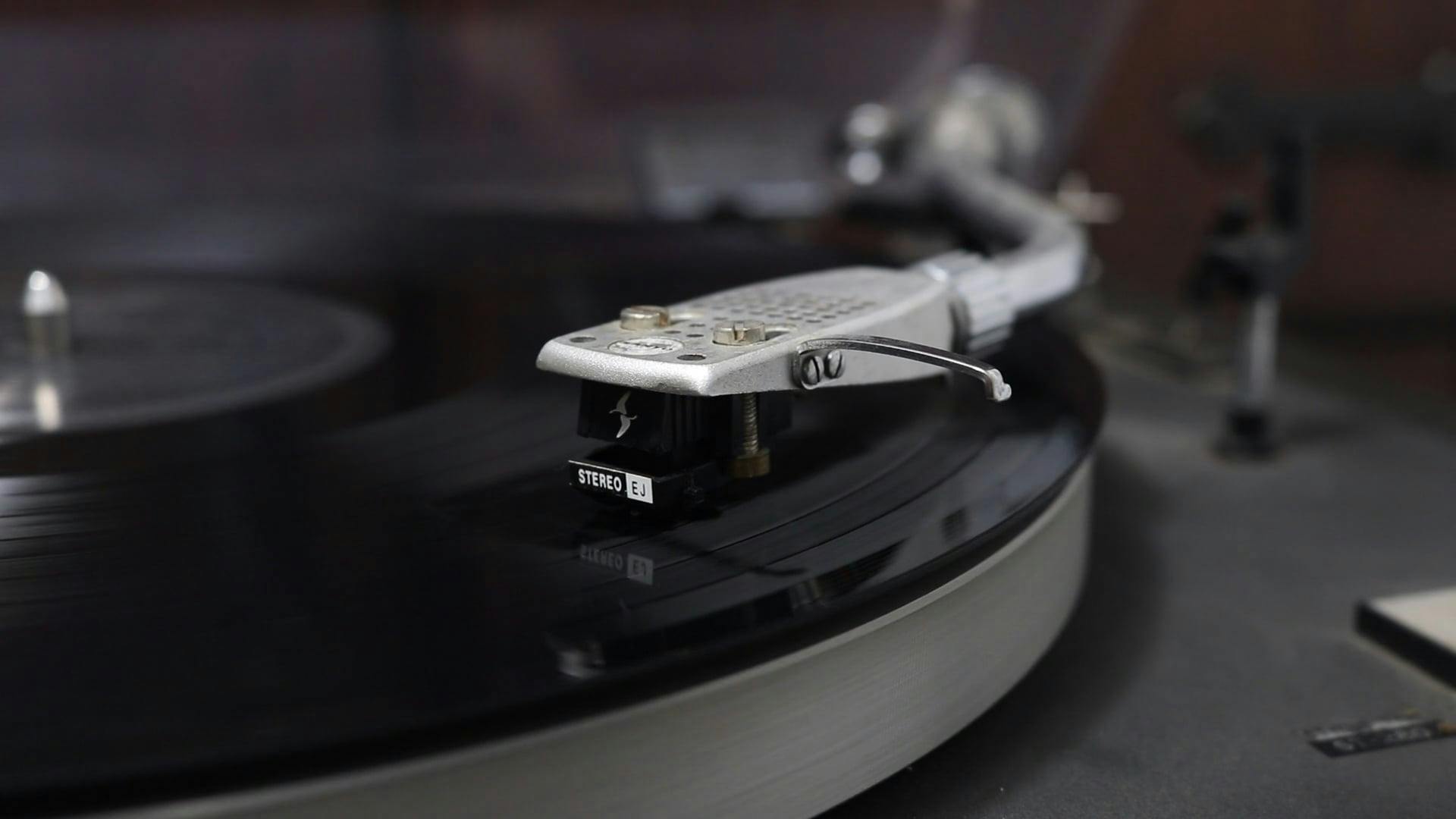 Vinyl record playing on old vintage turntable. Close-up of needle on ...