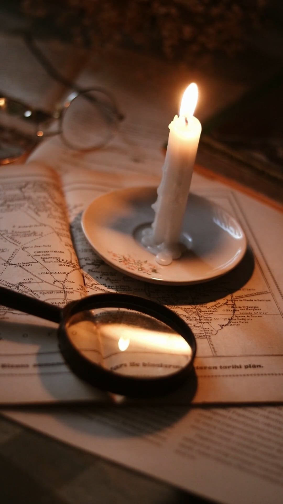A candle and a magnifying glass on a table Free Stock Video Footage ...