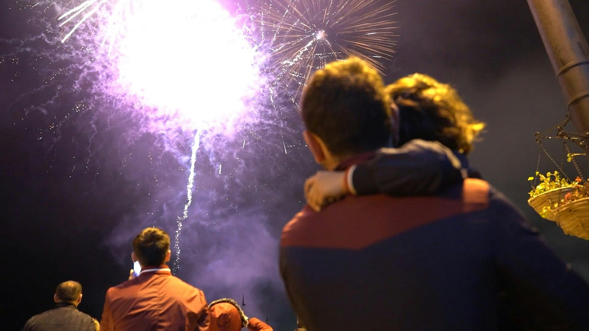 Fireworks. A father watches fireworks with a baby in his arms Free ...