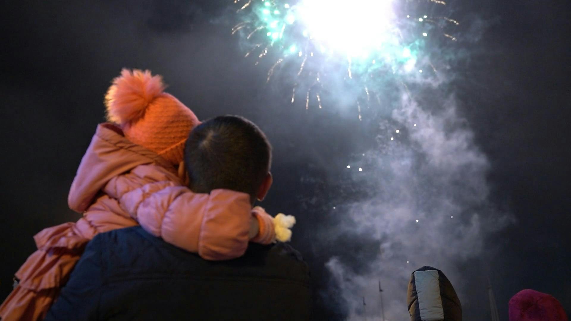 Fireworks. A father watches fireworks with a baby in his arms Free ...