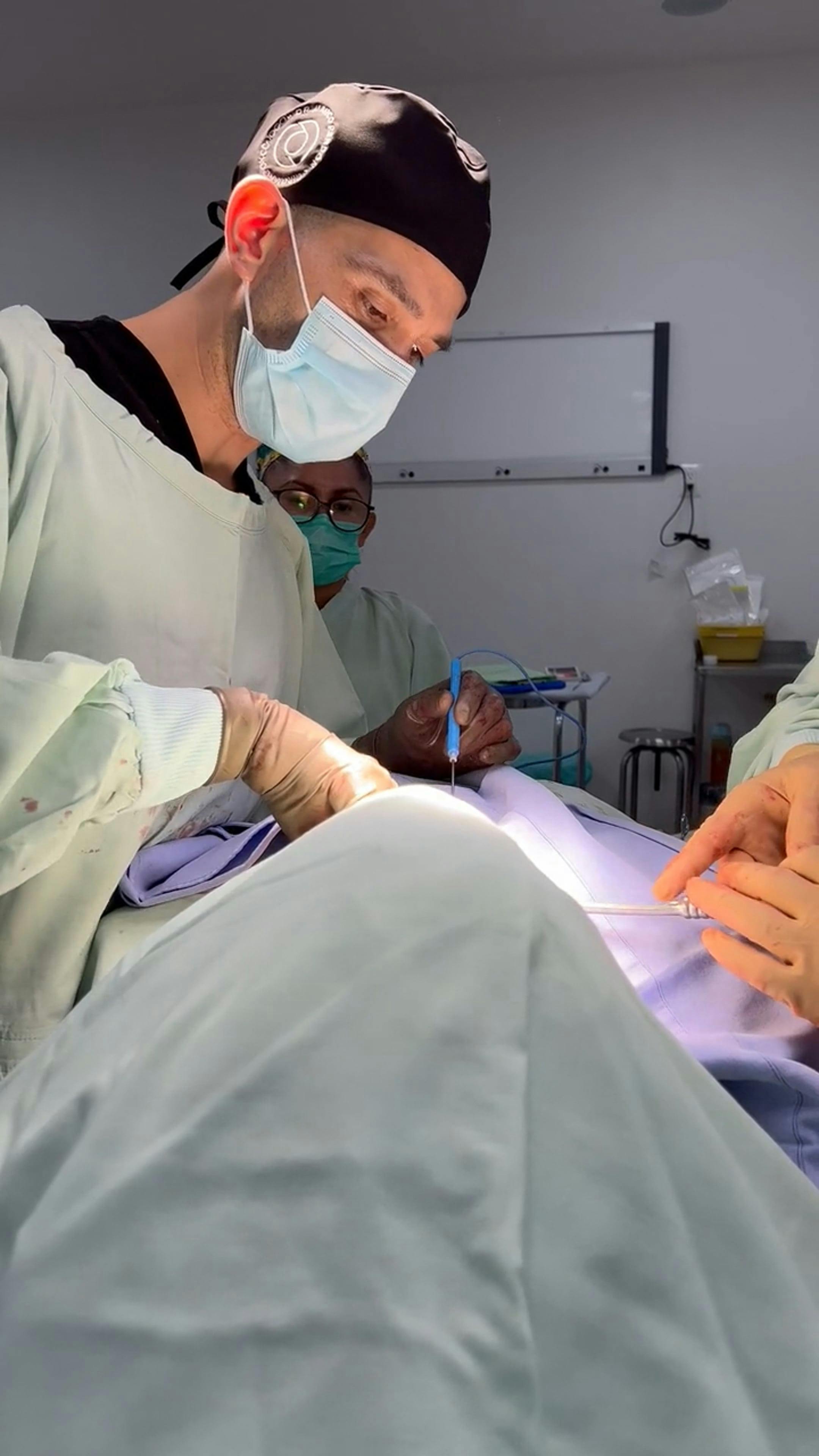 Two surgeons in surgical gowns performing surgery Free Stock Video ...