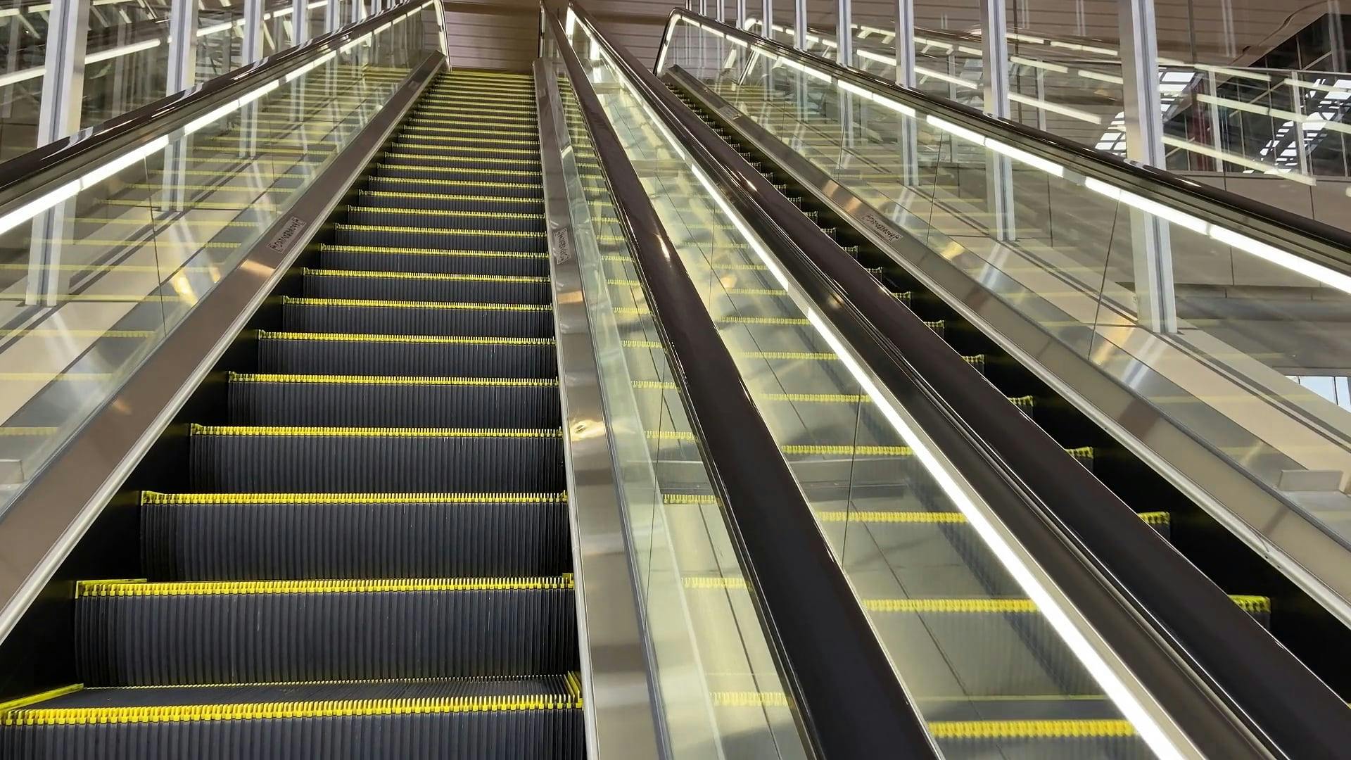 Escalators in an airport with yellow and black rails Free Stock Video ...