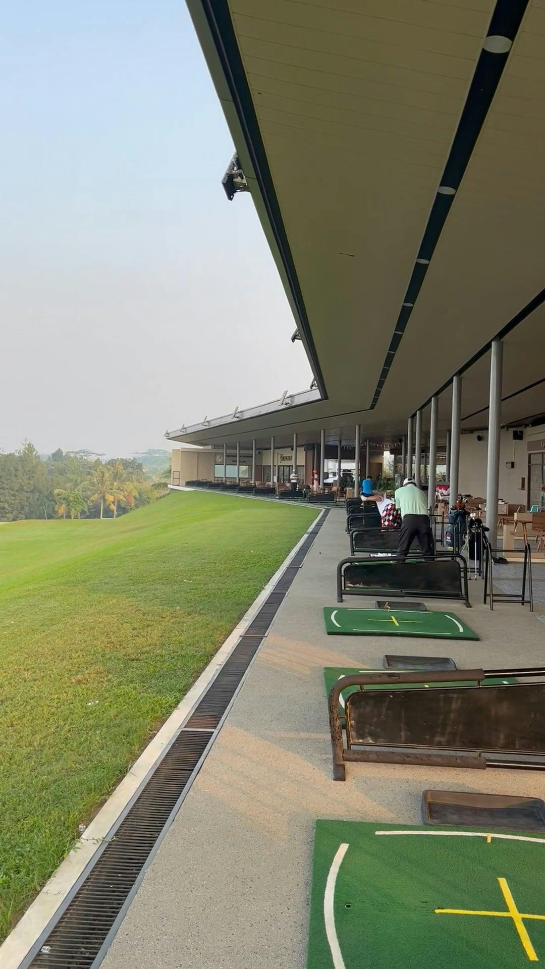 A golf course with a large green field and a large hill Free Stock ...