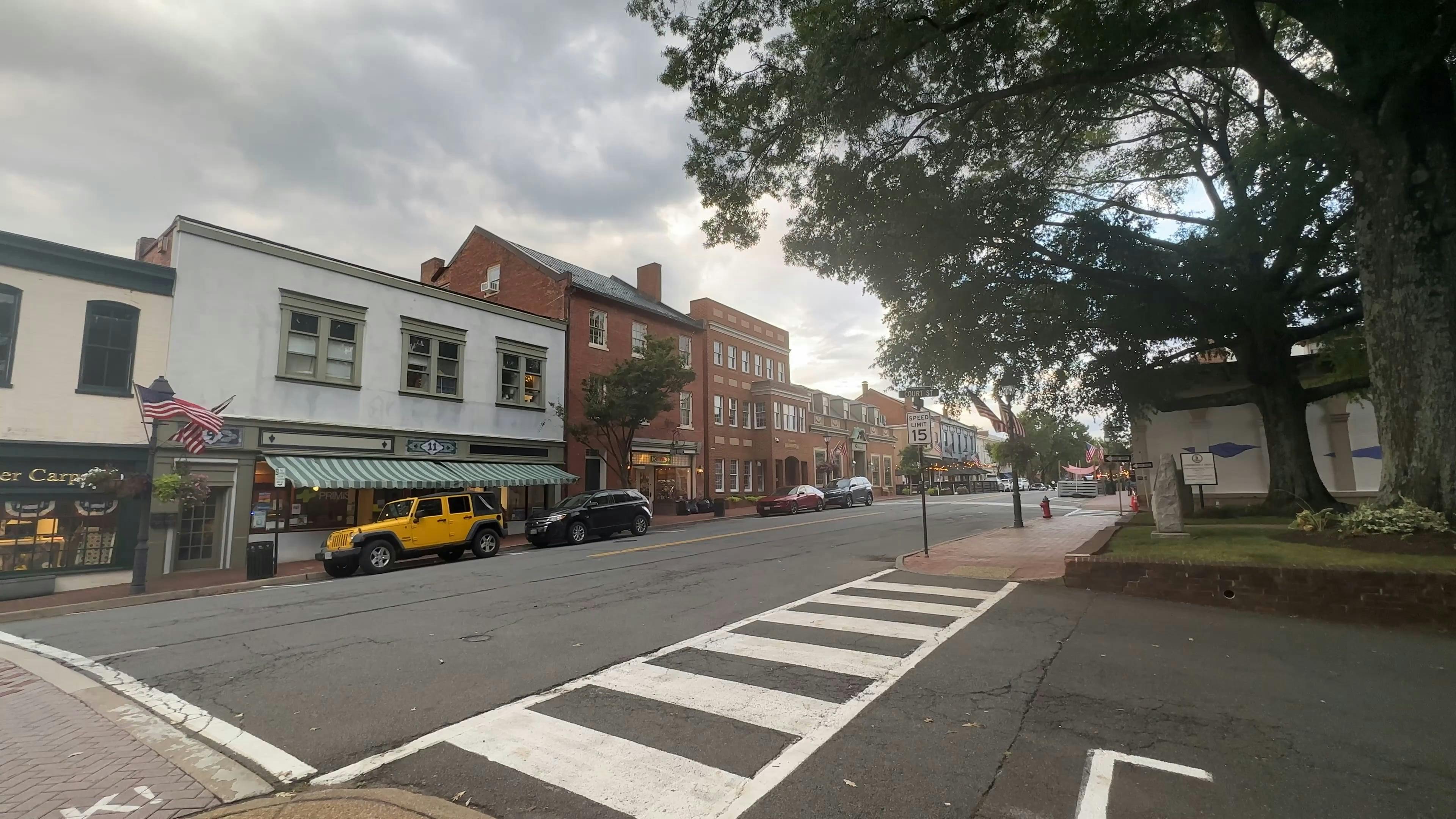 A google street view image of a street with cars and buildings Free ...