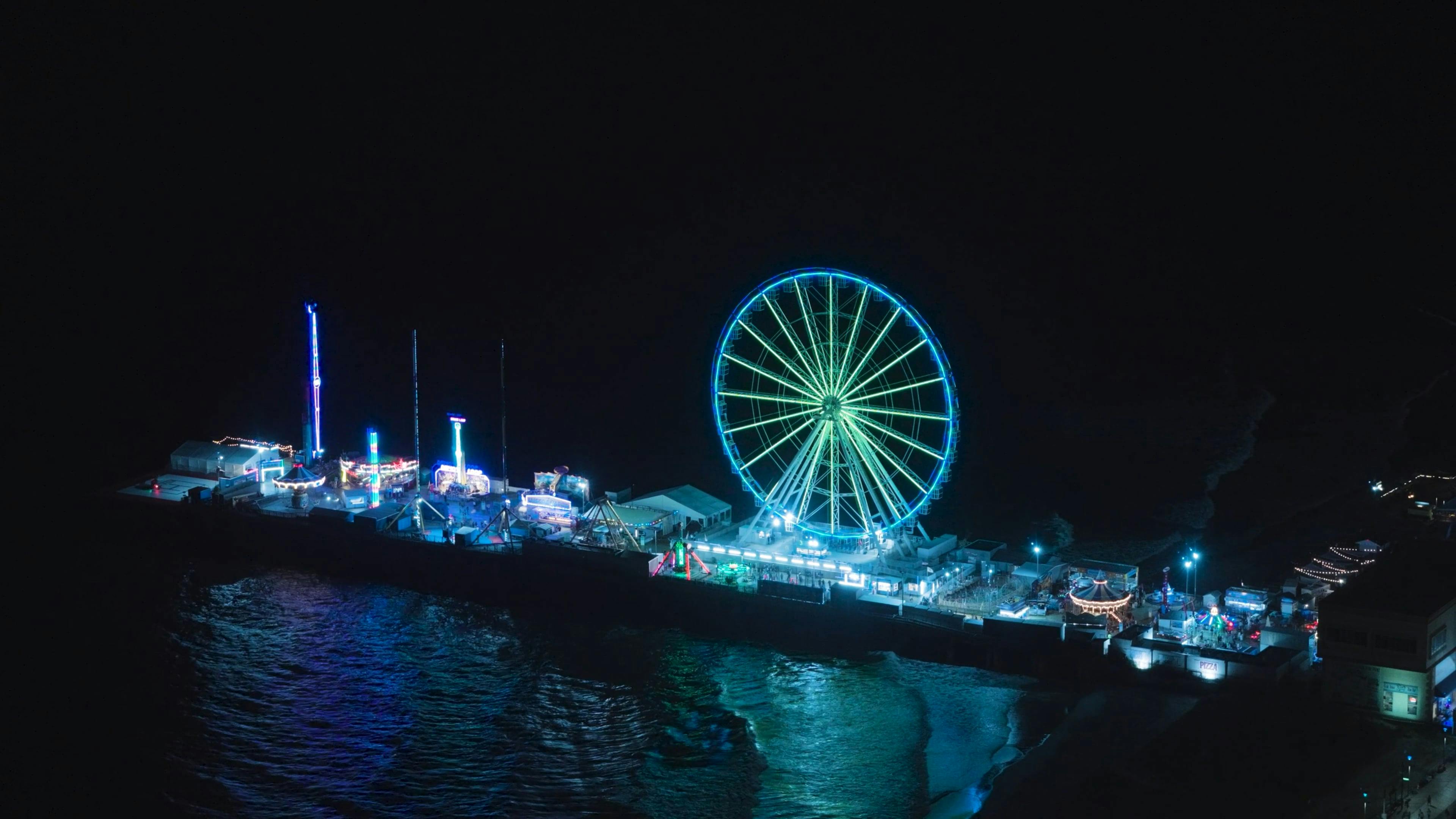 Festival Lights Reflect in Ocean - Neon strobing colorful lights of ...