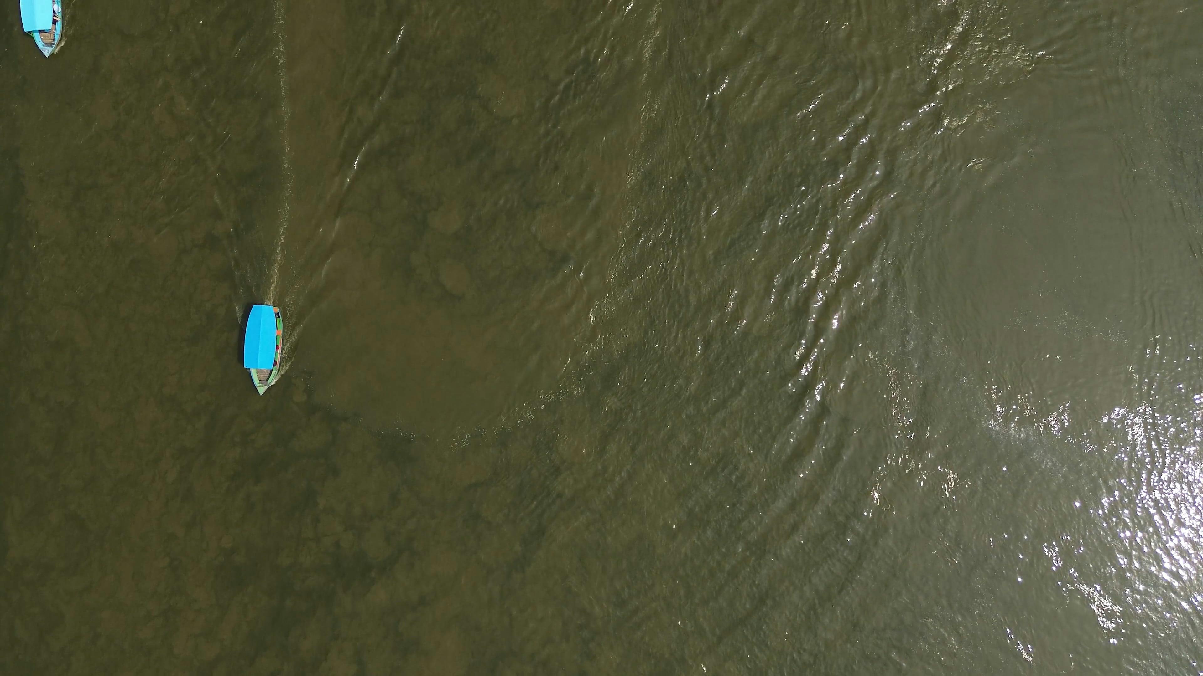 Aerial view of a small boat floating in the water Free Stock Video ...