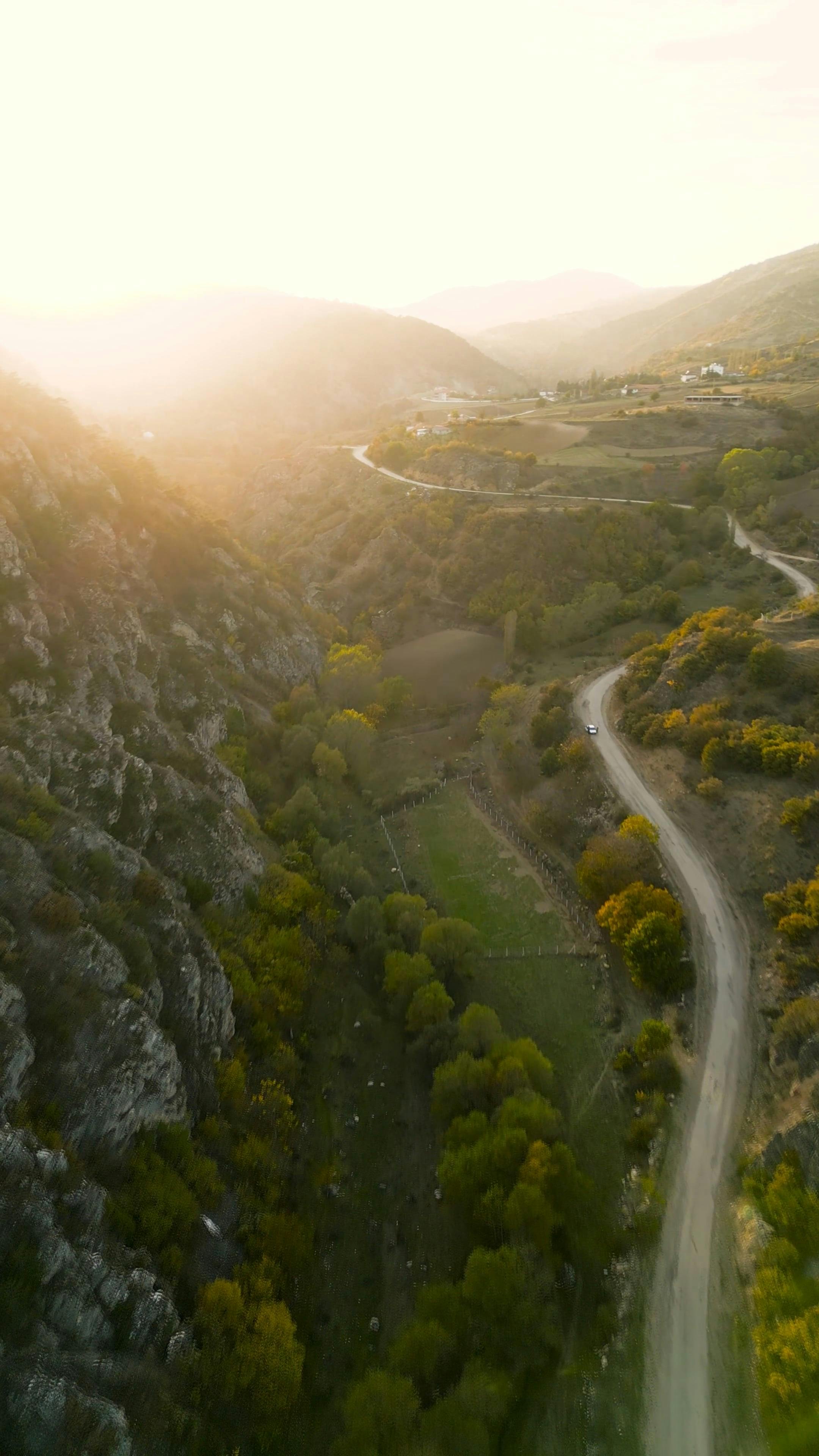 A scenic view of a road with trees and hills Free Stock Video Footage ...