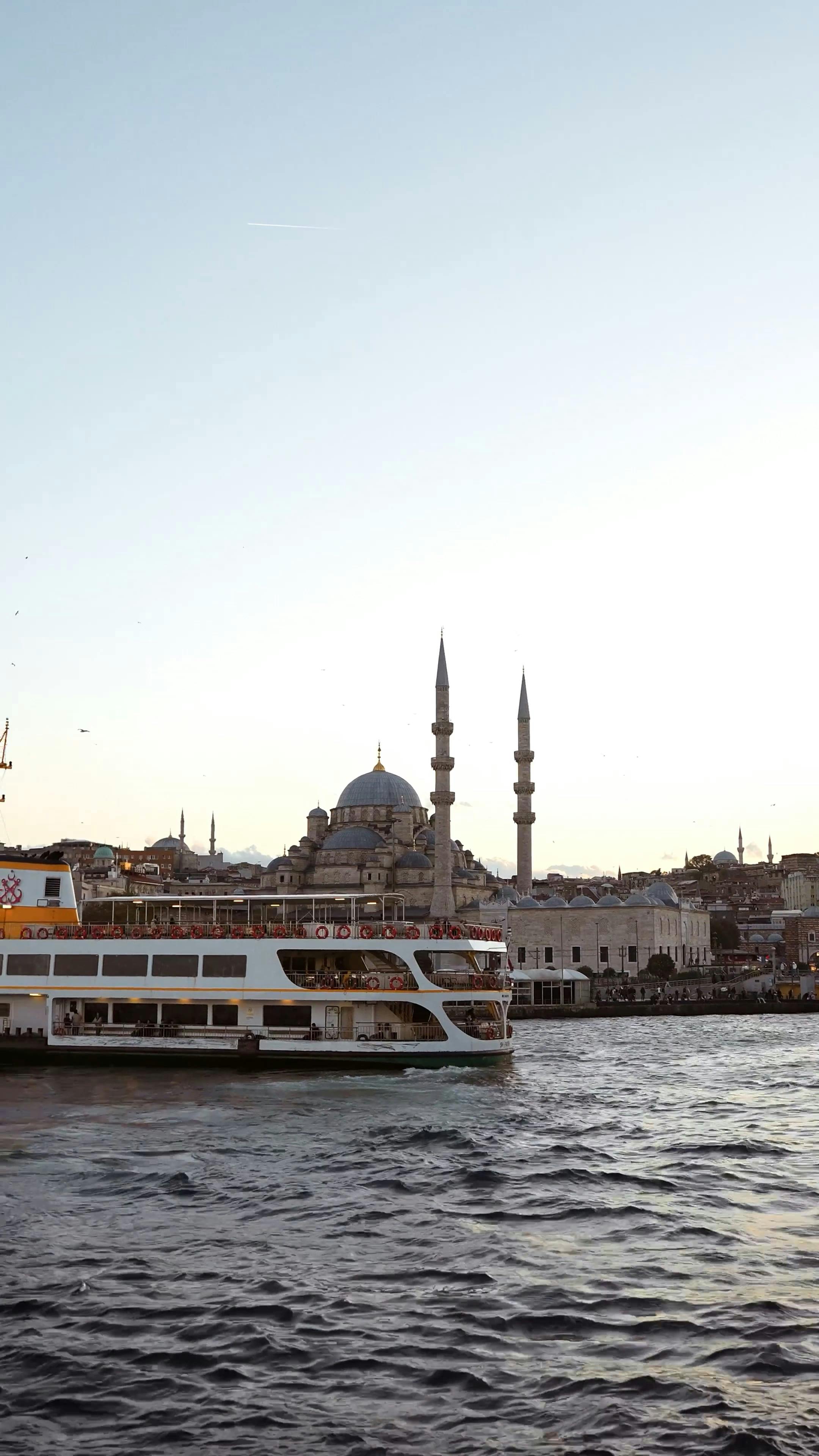 A boat is traveling on the water near a mosque Free Stock Video Footage ...