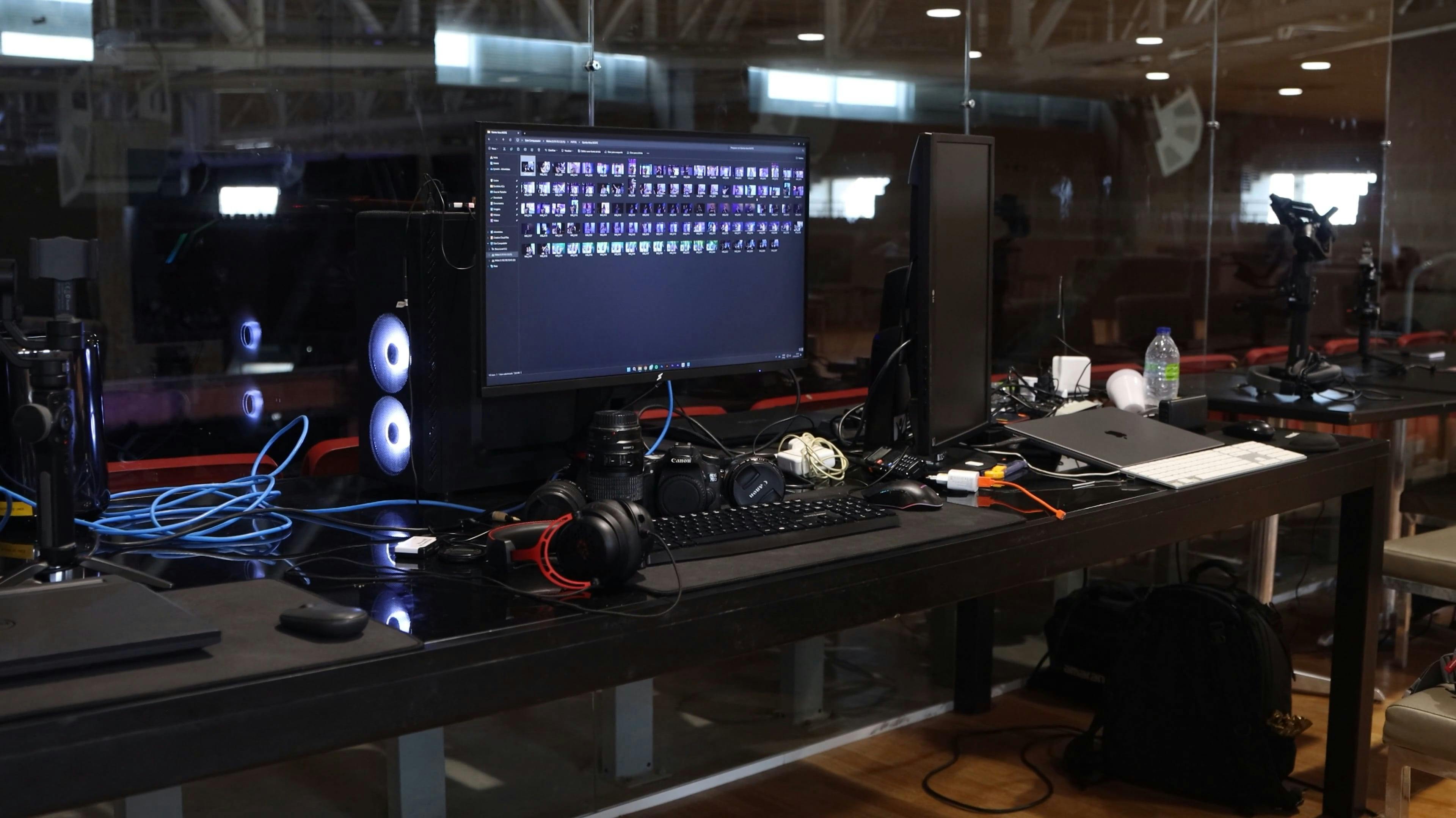 A computer desk with a computer monitor and keyboard Free Stock Video ...