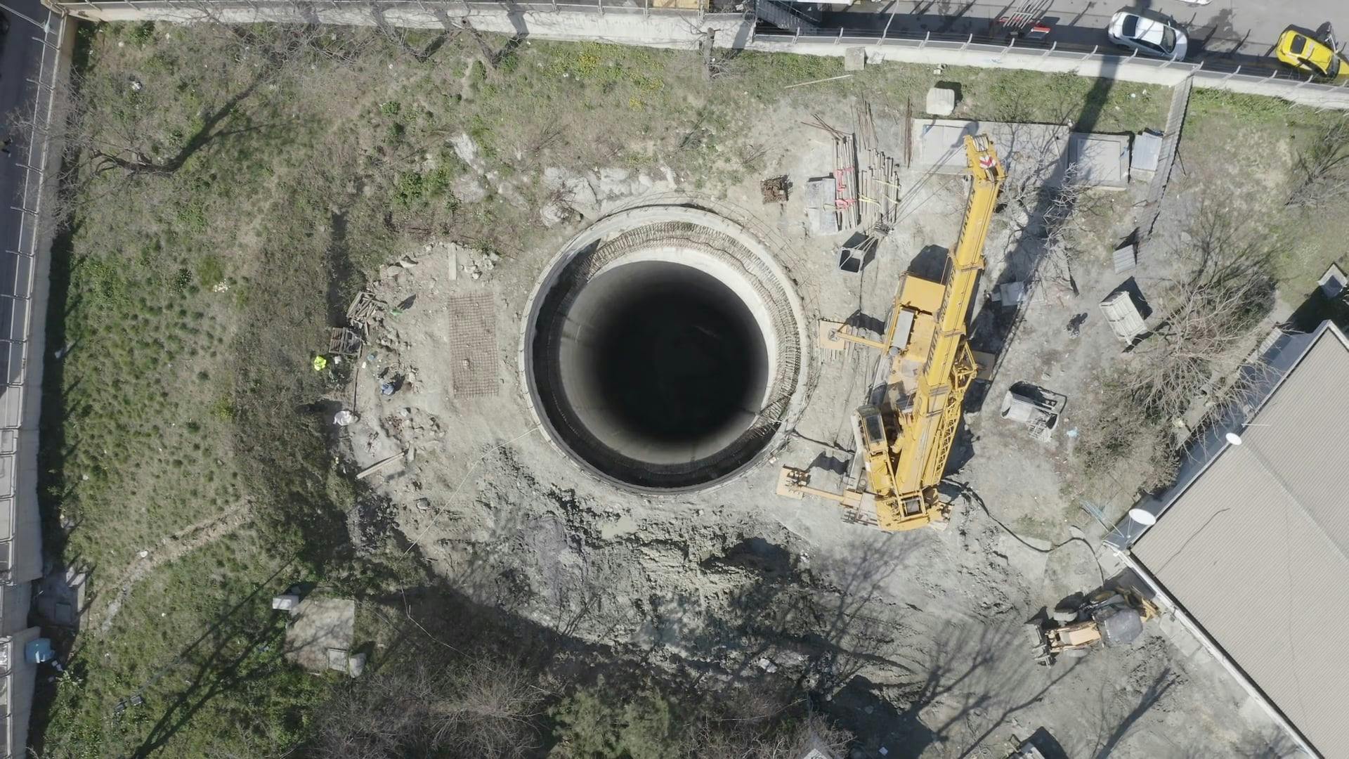 An aerial view of a construction site with a large hole in the ground ...