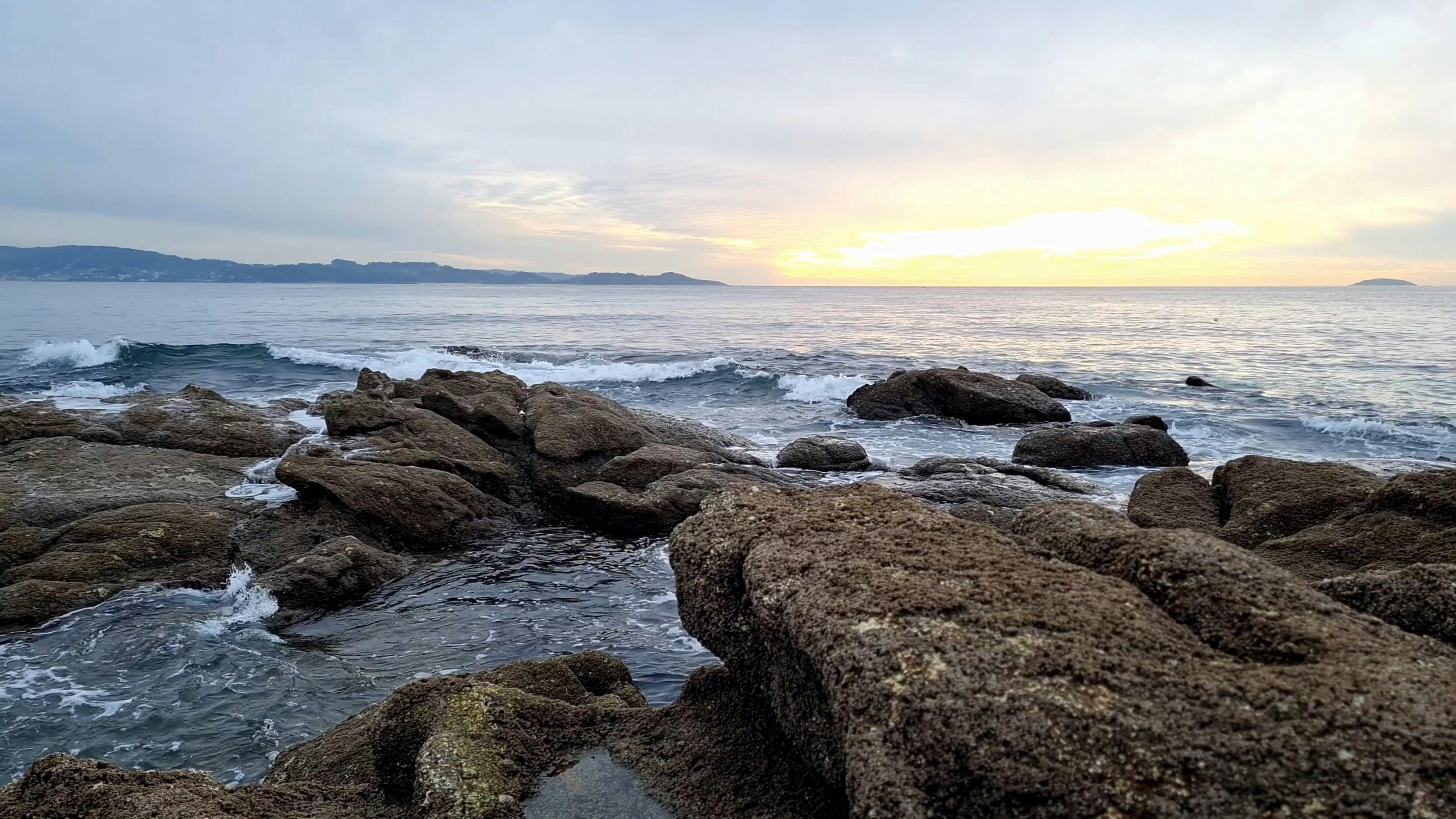 A sunset over the ocean with rocks and water Free Stock Video Footage ...