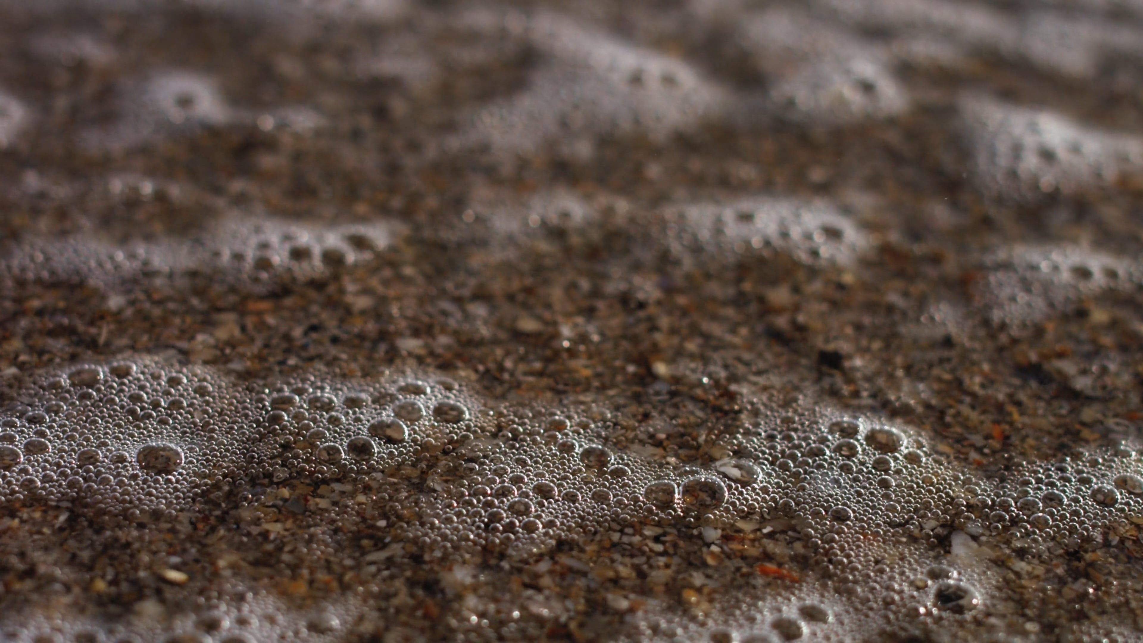 A close up of a wet sand with bubbles Free Stock Video Footage, Royalty ...