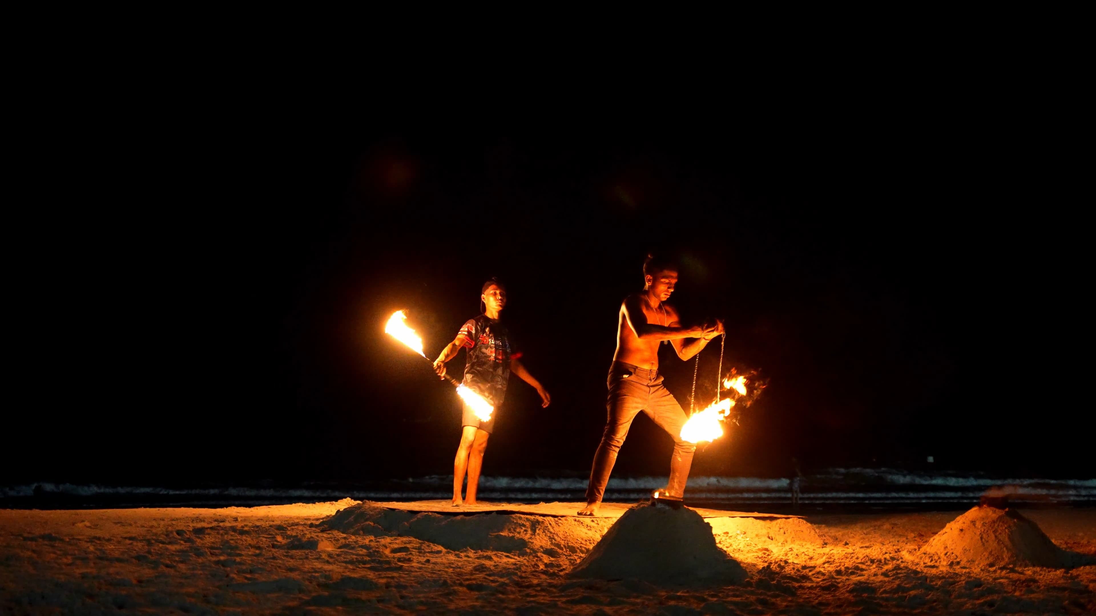 Two people performing a fire show on the beach Free Stock Video Footage ...