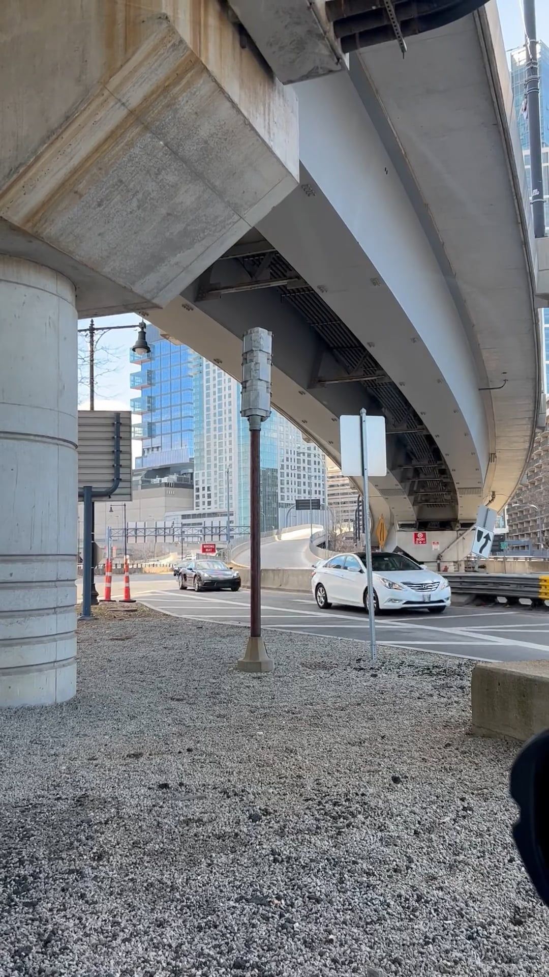 A view of a highway underpass with cars driving under it Free Stock ...