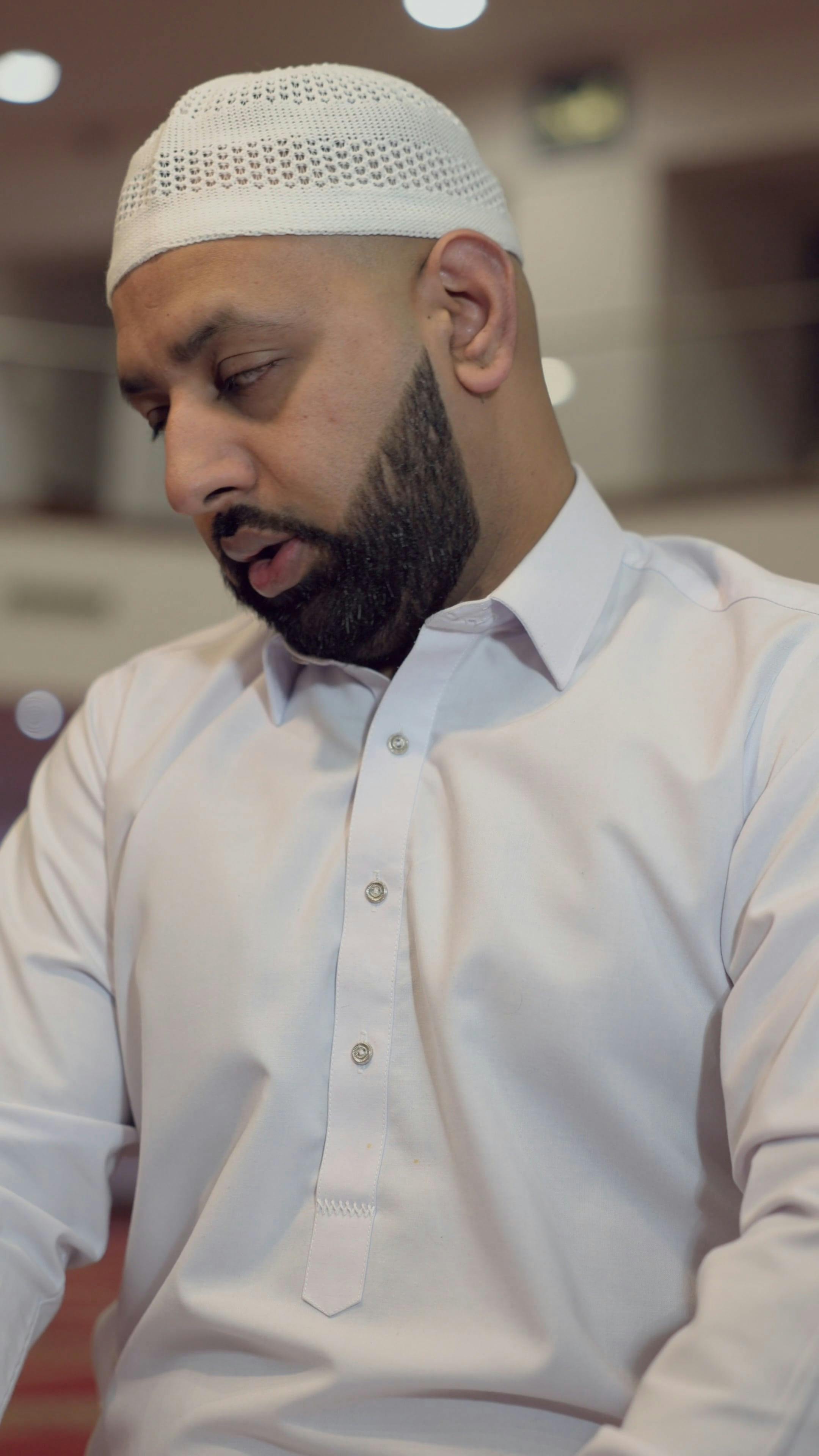 A man standing in a mosque with a white carpet Free Stock Video Footage ...