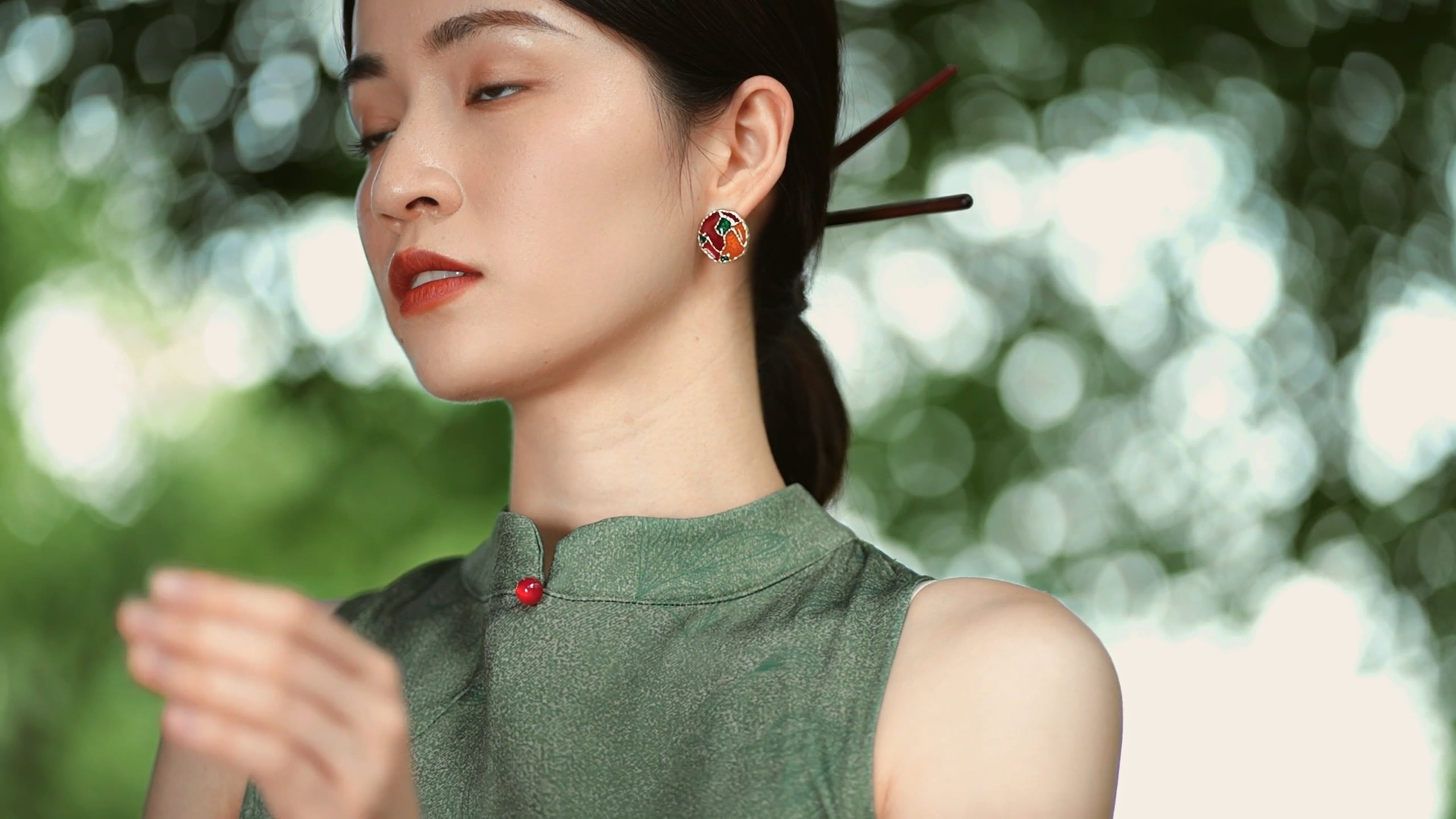 A woman in a green dress with a red hair clip Free Stock Video Footage ...