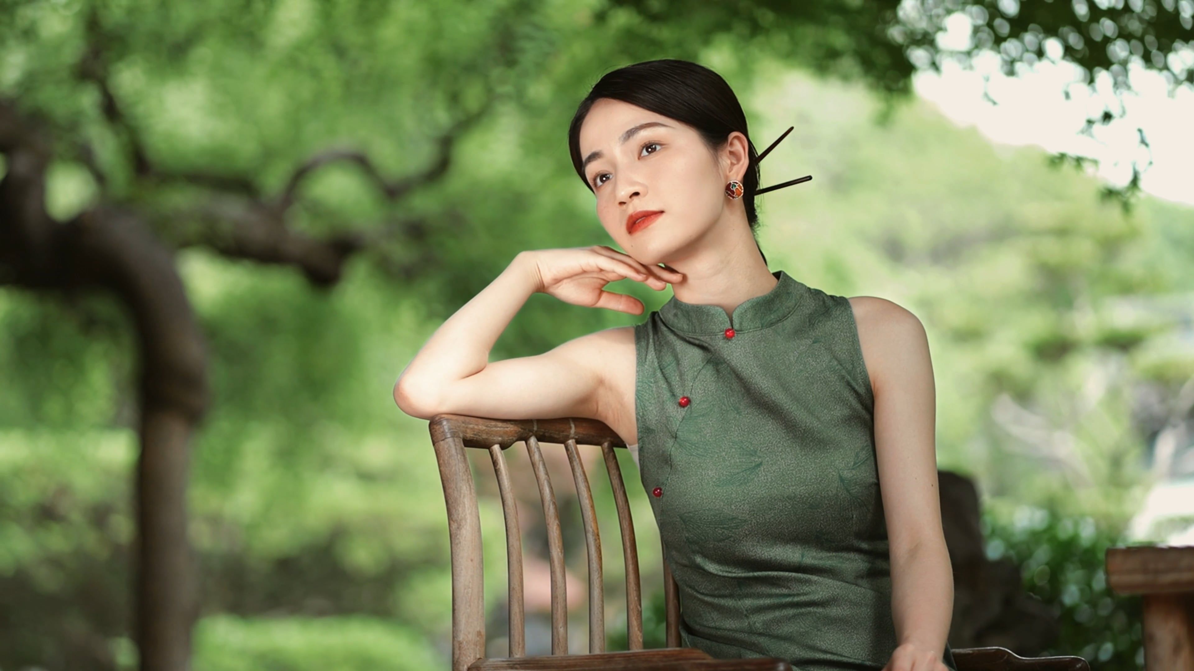 A woman in a green dress sitting on a bench Free Stock Video Footage ...