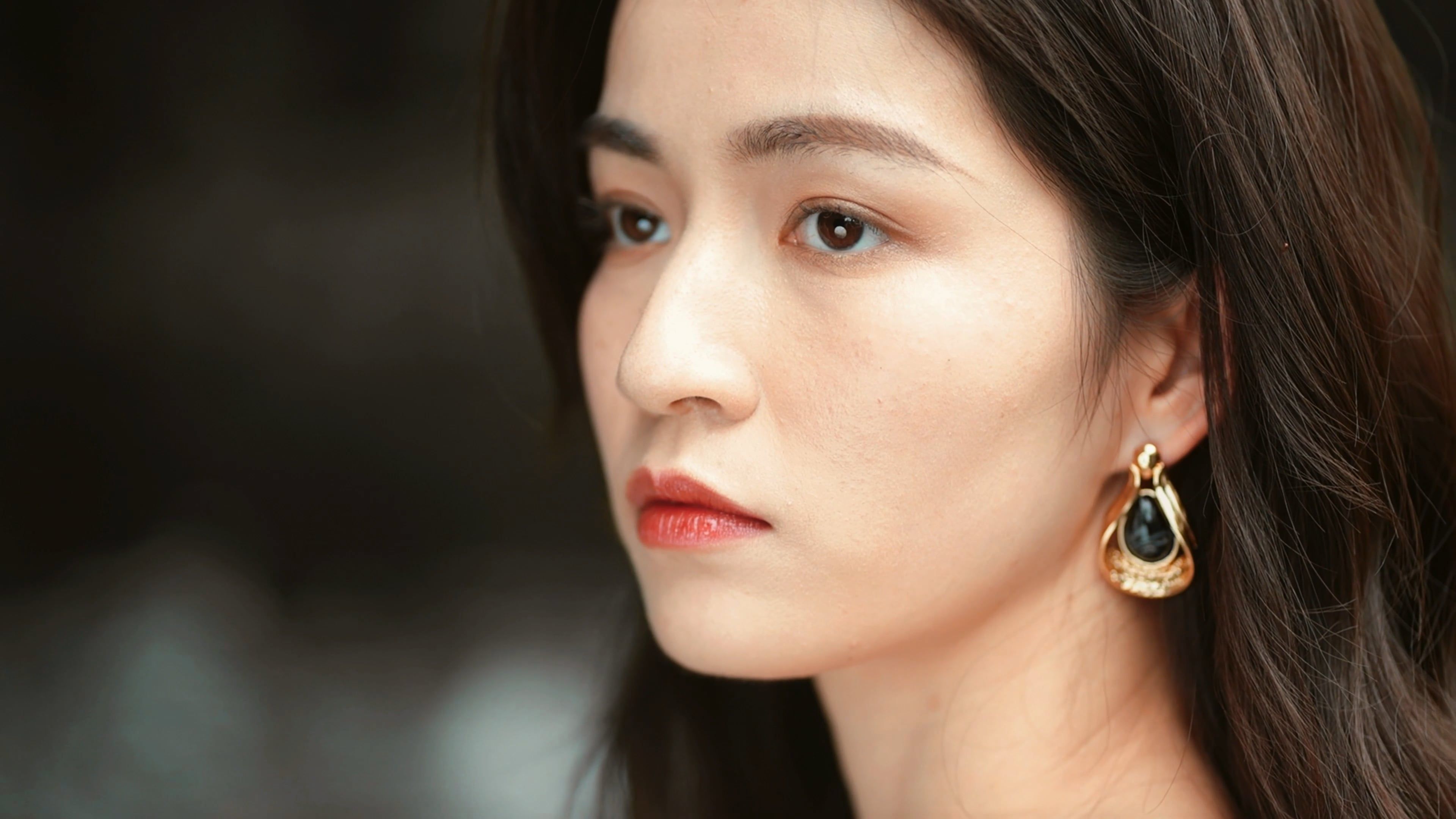 A woman with long hair and earrings Free Stock Video Footage, Royalty ...