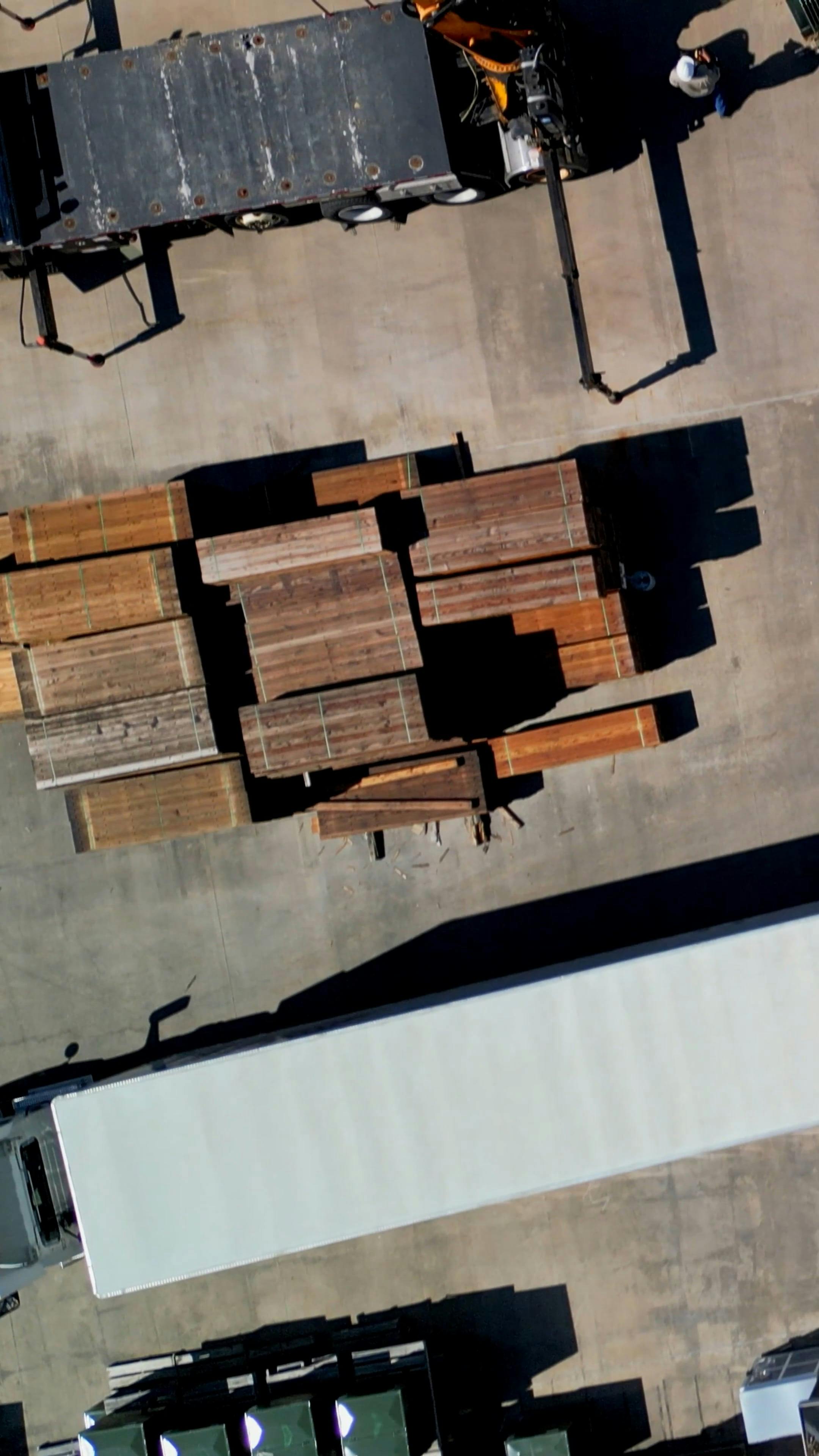 An aerial view of a warehouse with trucks parked outside Free Stock ...