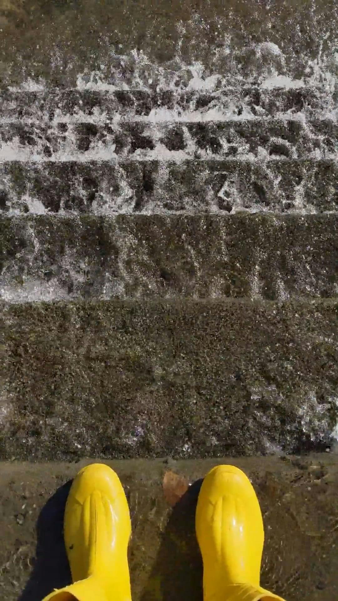 A woman in boots standing in a puddle Free Stock Video Footage, Royalty ...