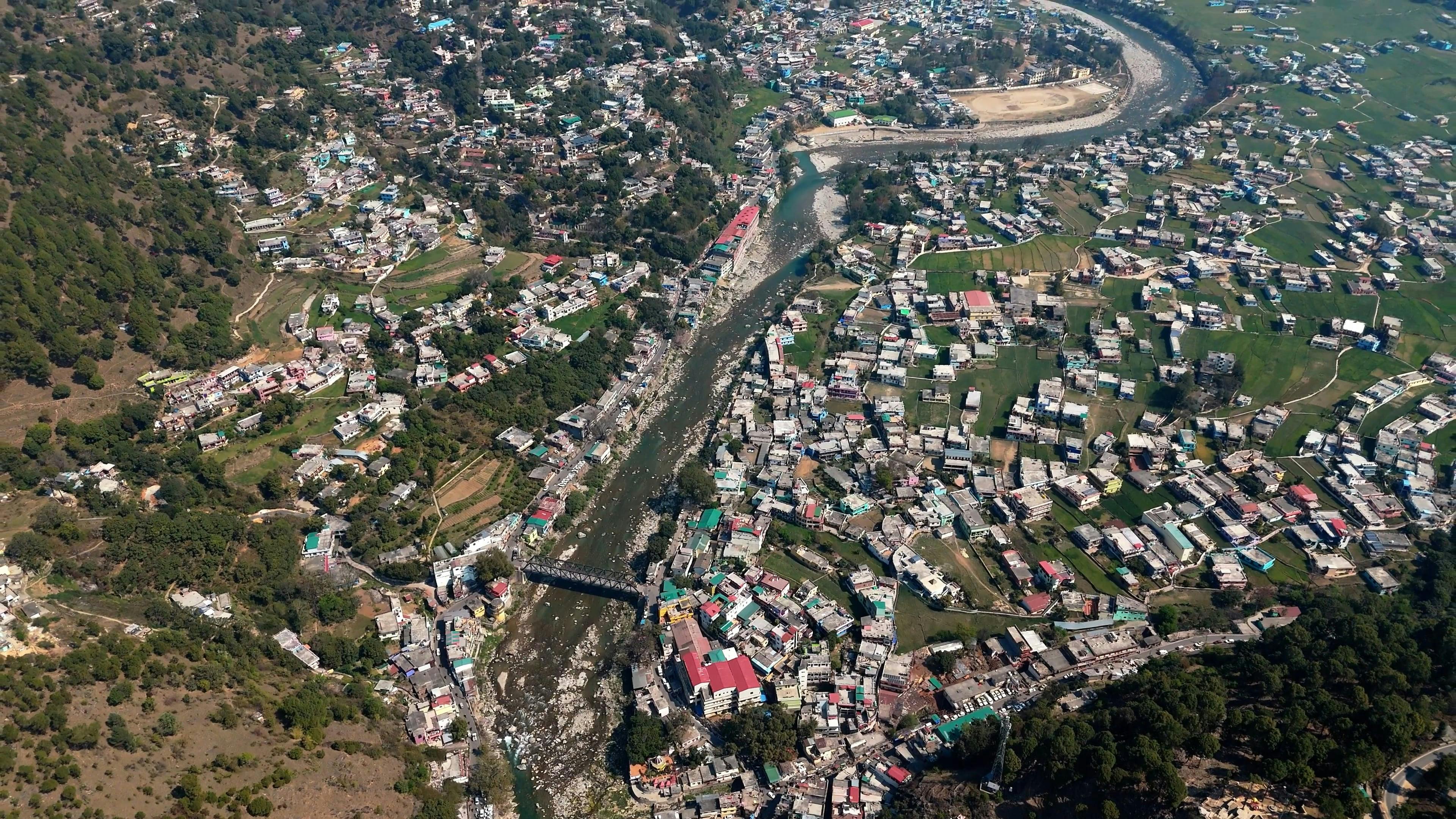 A hill town in a Himalayan valley in front of mountains, Bageshwar ...
