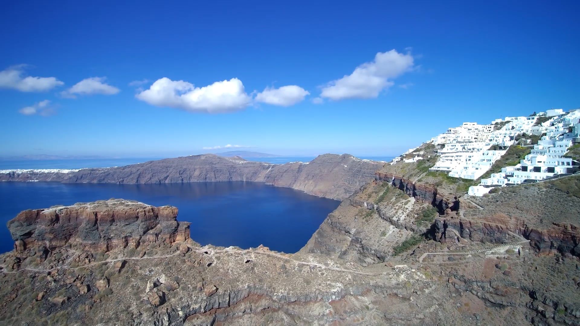 The blue waters of santorini are surrounded by cliffs Free Stock Video ...