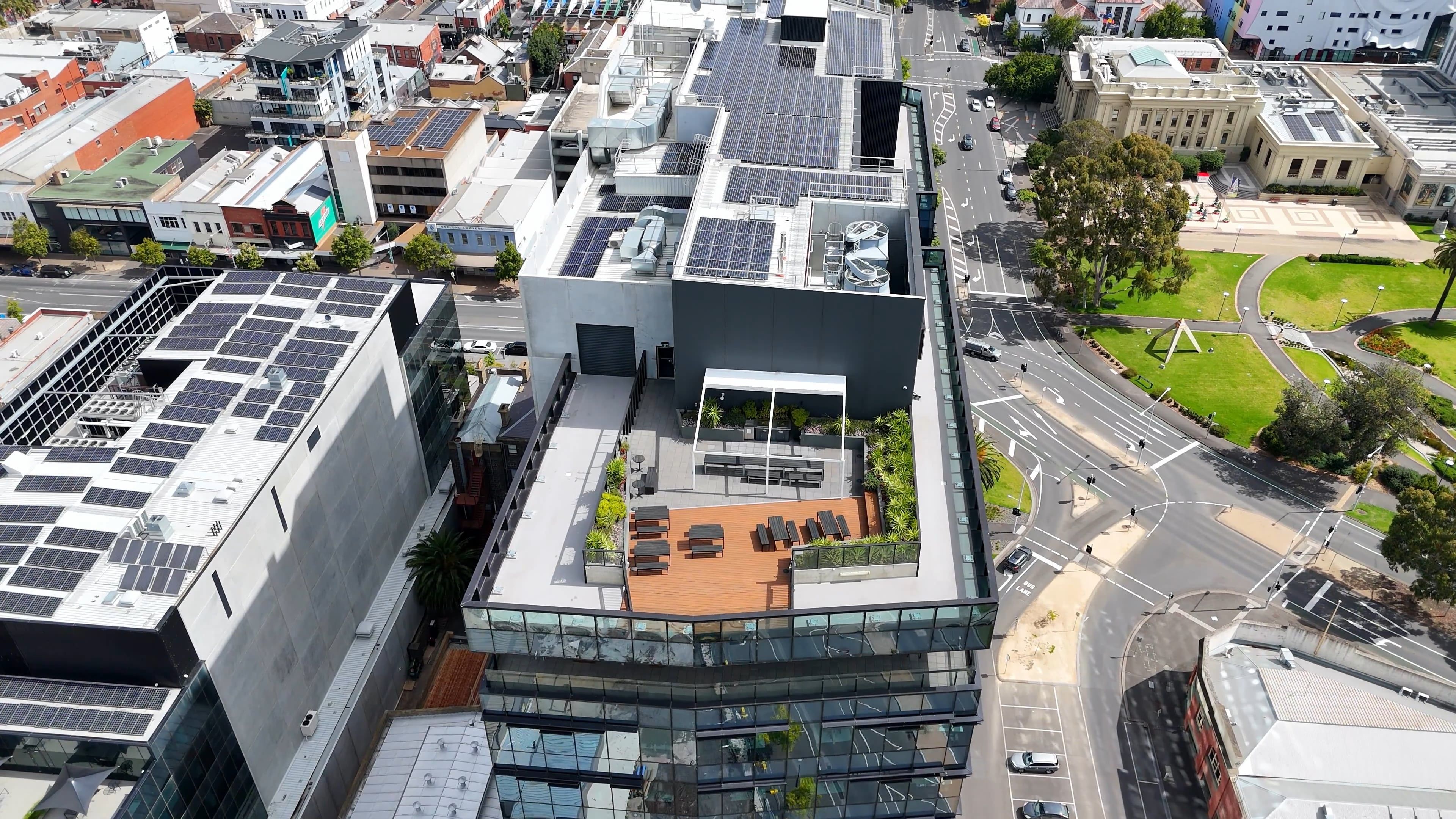 An aerial view of a building with solar panels on the roof Free Stock ...